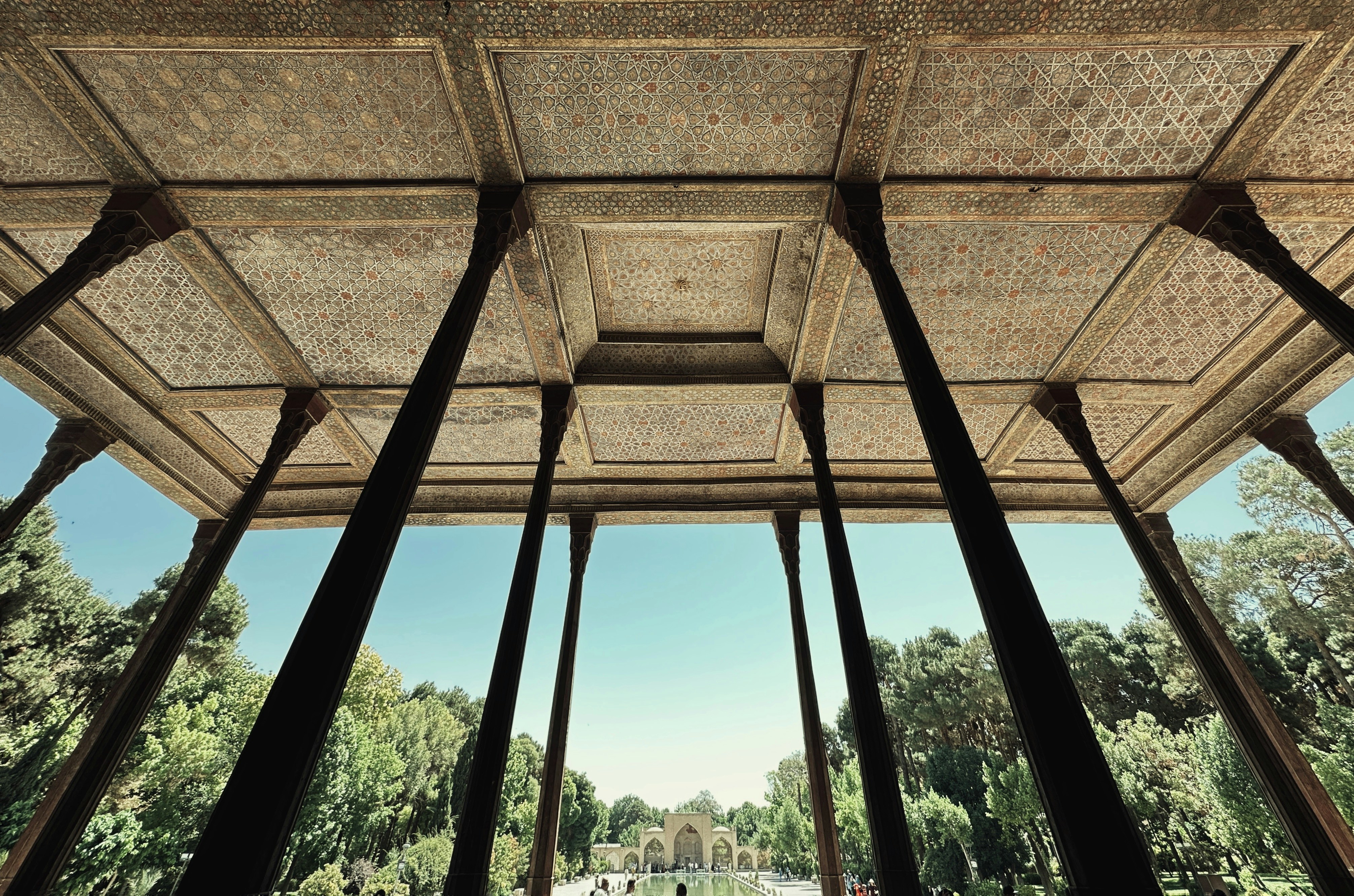 Underneath the Canopy: A Framing of Columns and Distant Garden