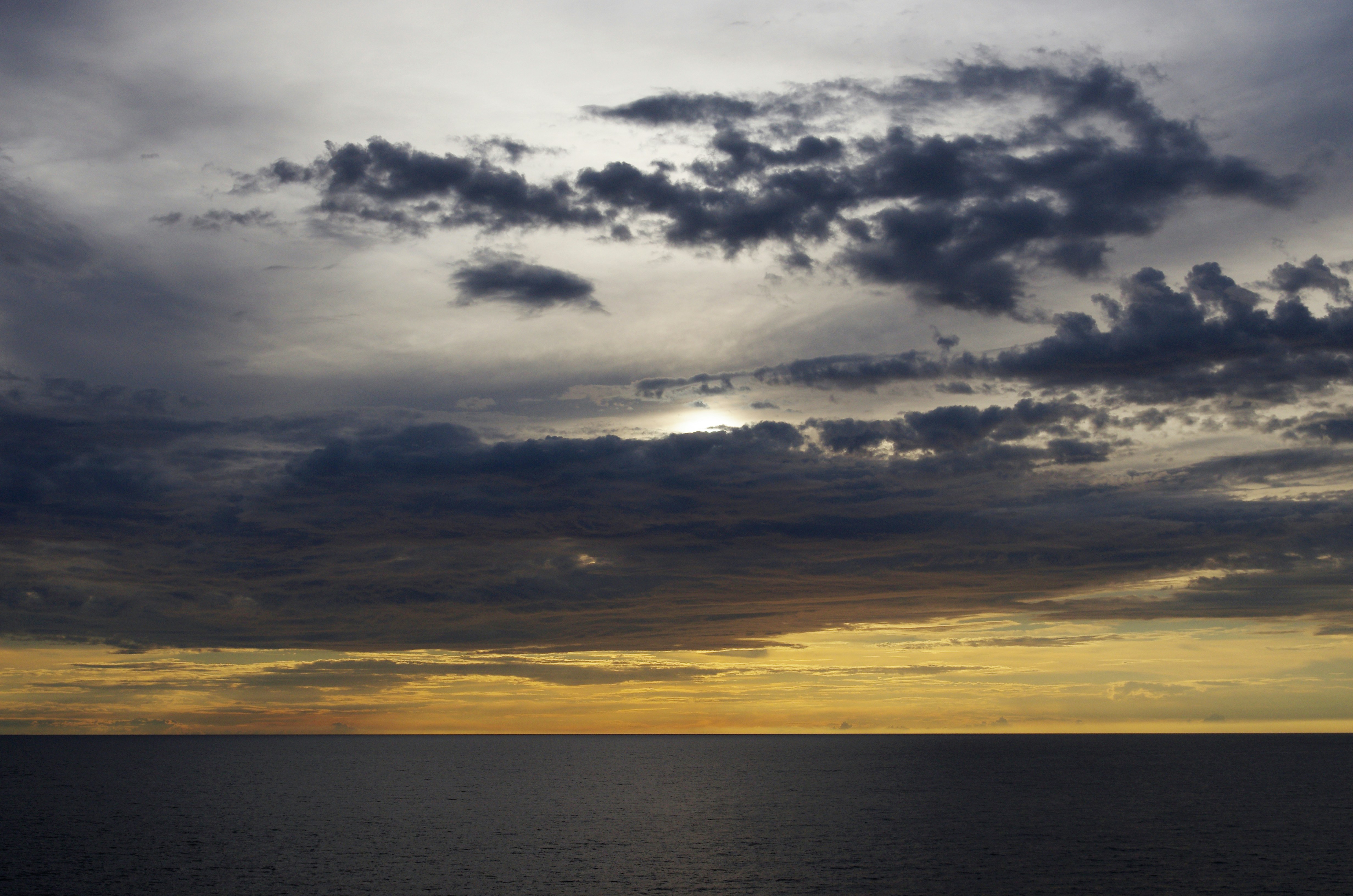 Horizon Burn: Quiet Sunset Over a Sleeping Sea
