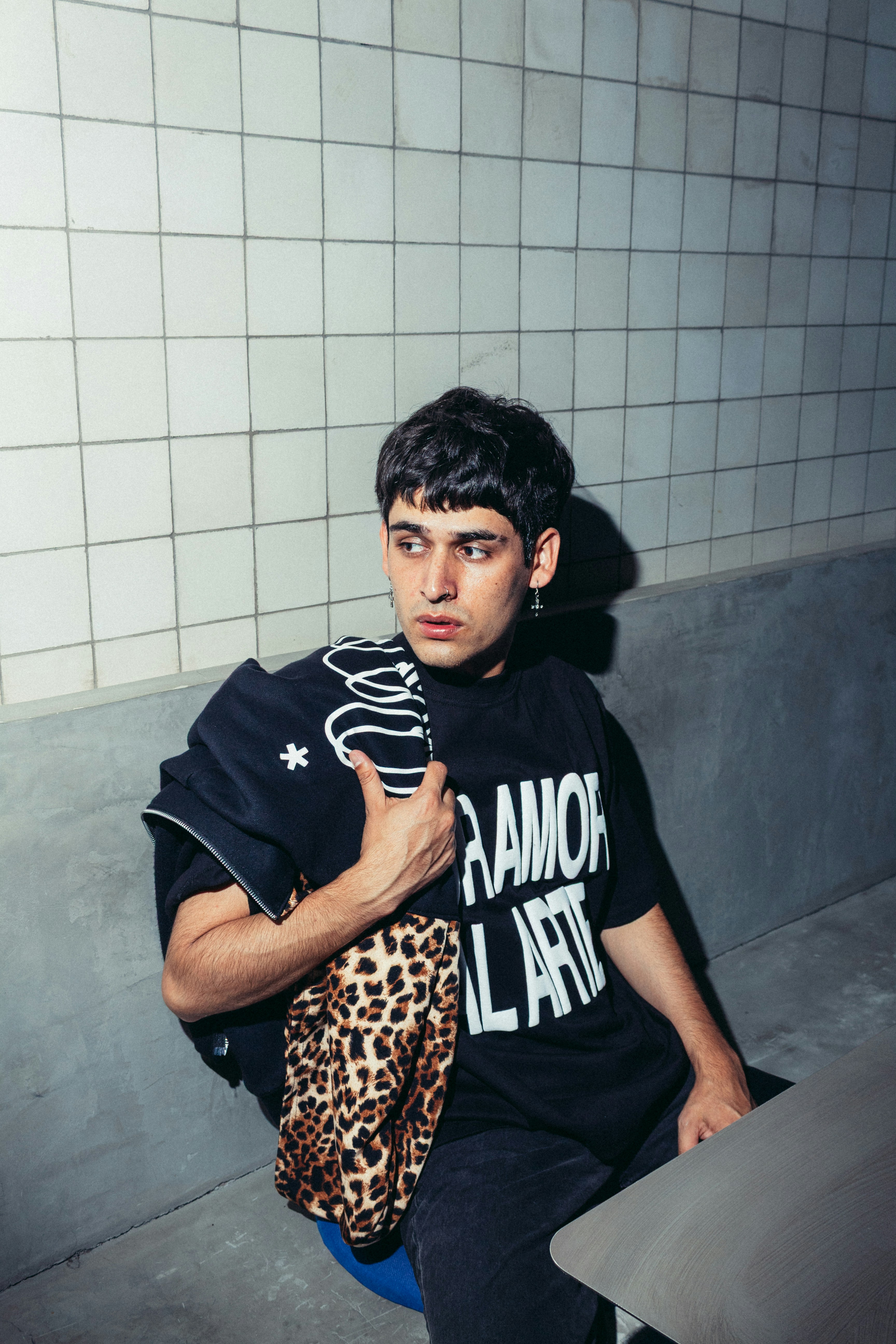 Undercurrents of Nightlife: A Quiet Moment with Leopard Print and Black Tee