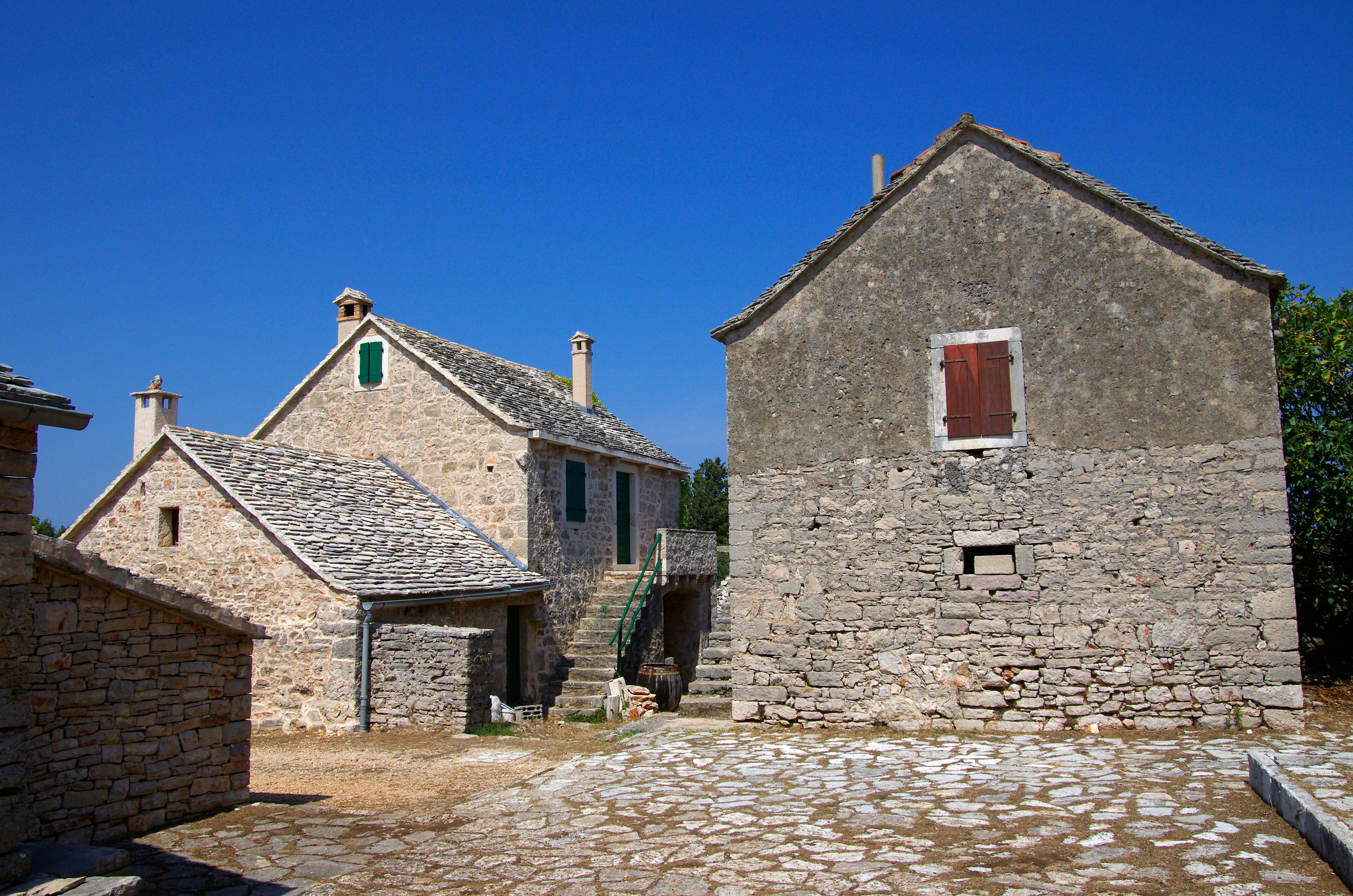 Stone Village Courtyard Under a Clear Blue Sky