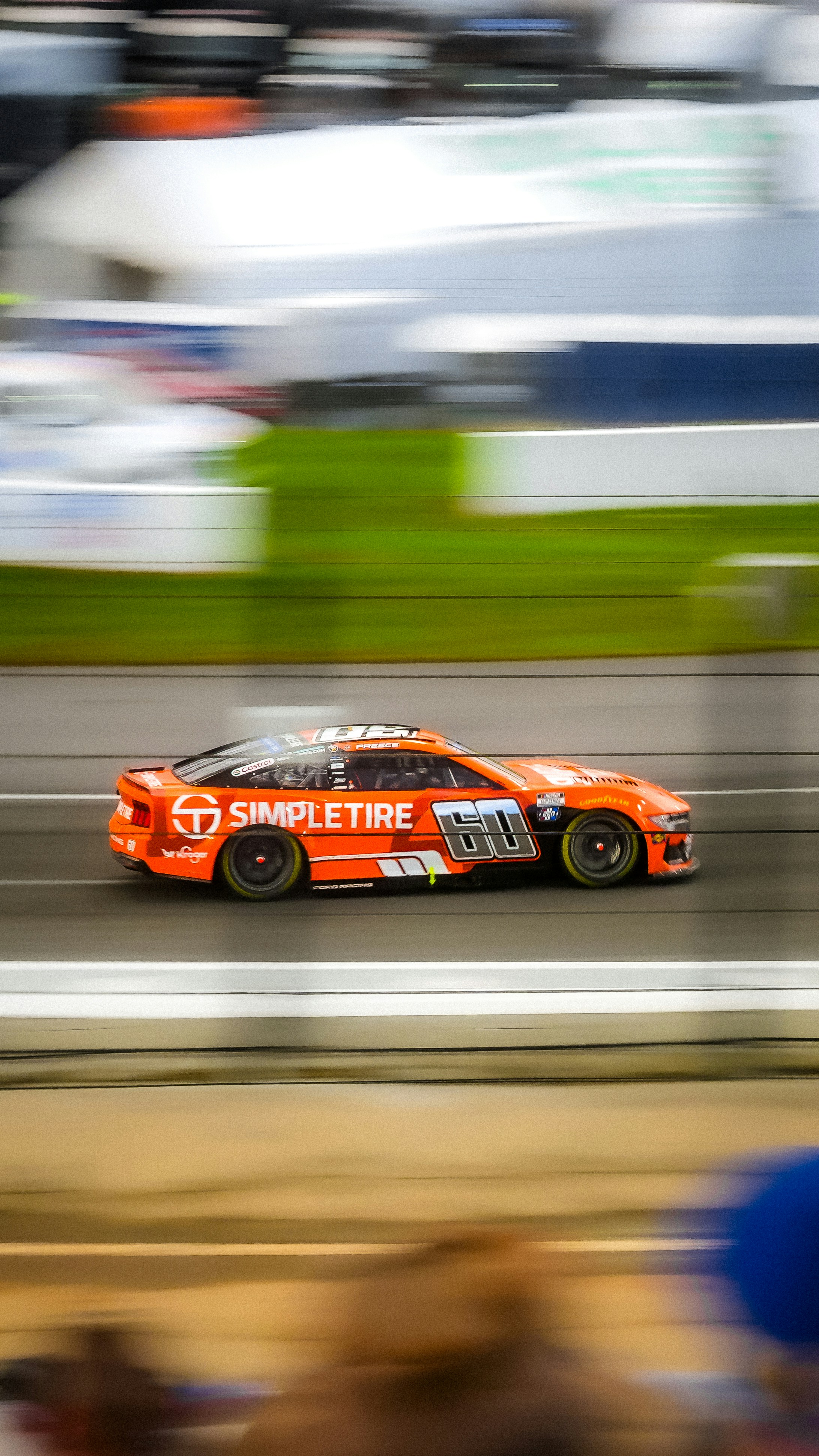 Orange race car in motion blur sprint on track