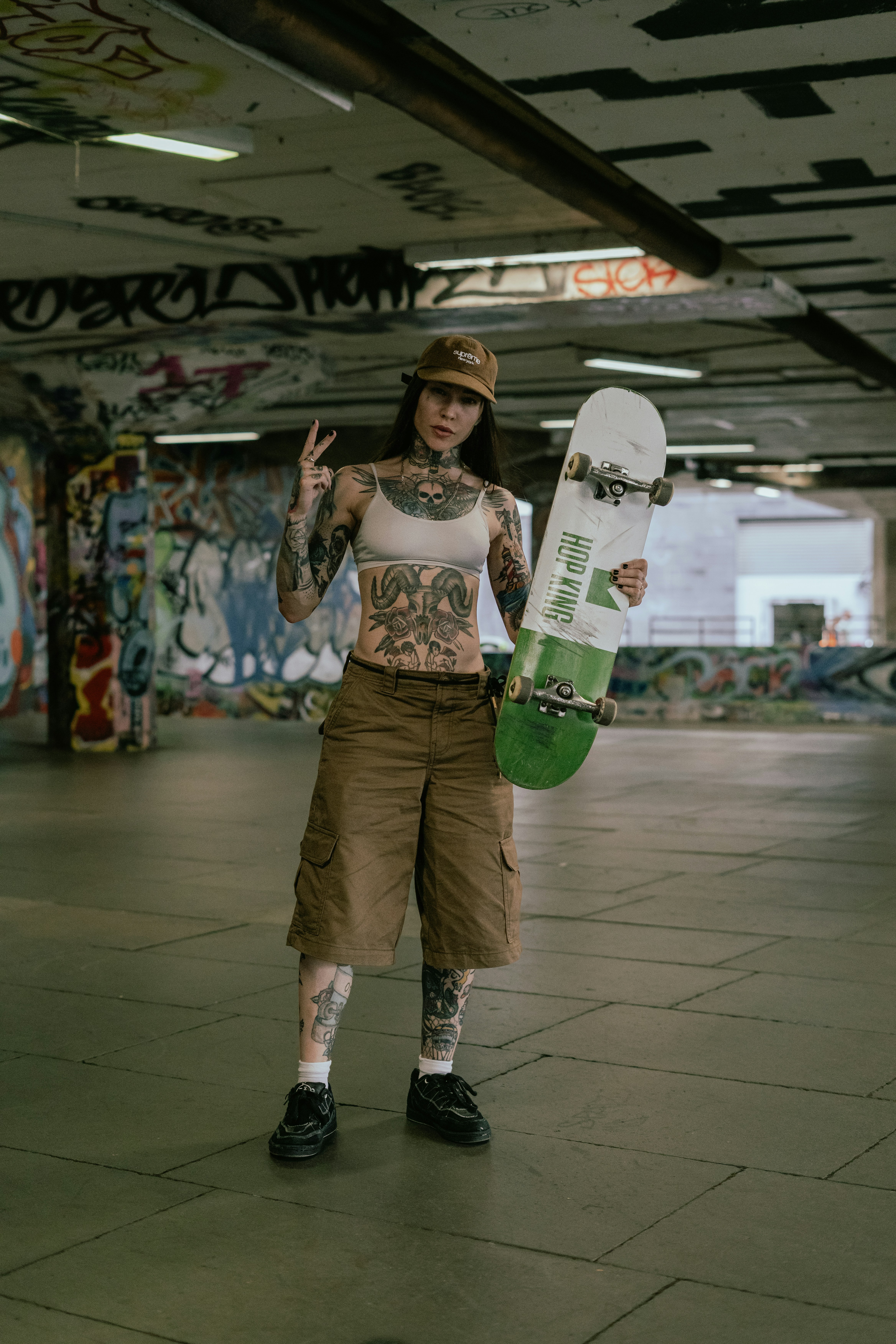 Skater with Tattooed Centerpiece Under Graffiti Canopy