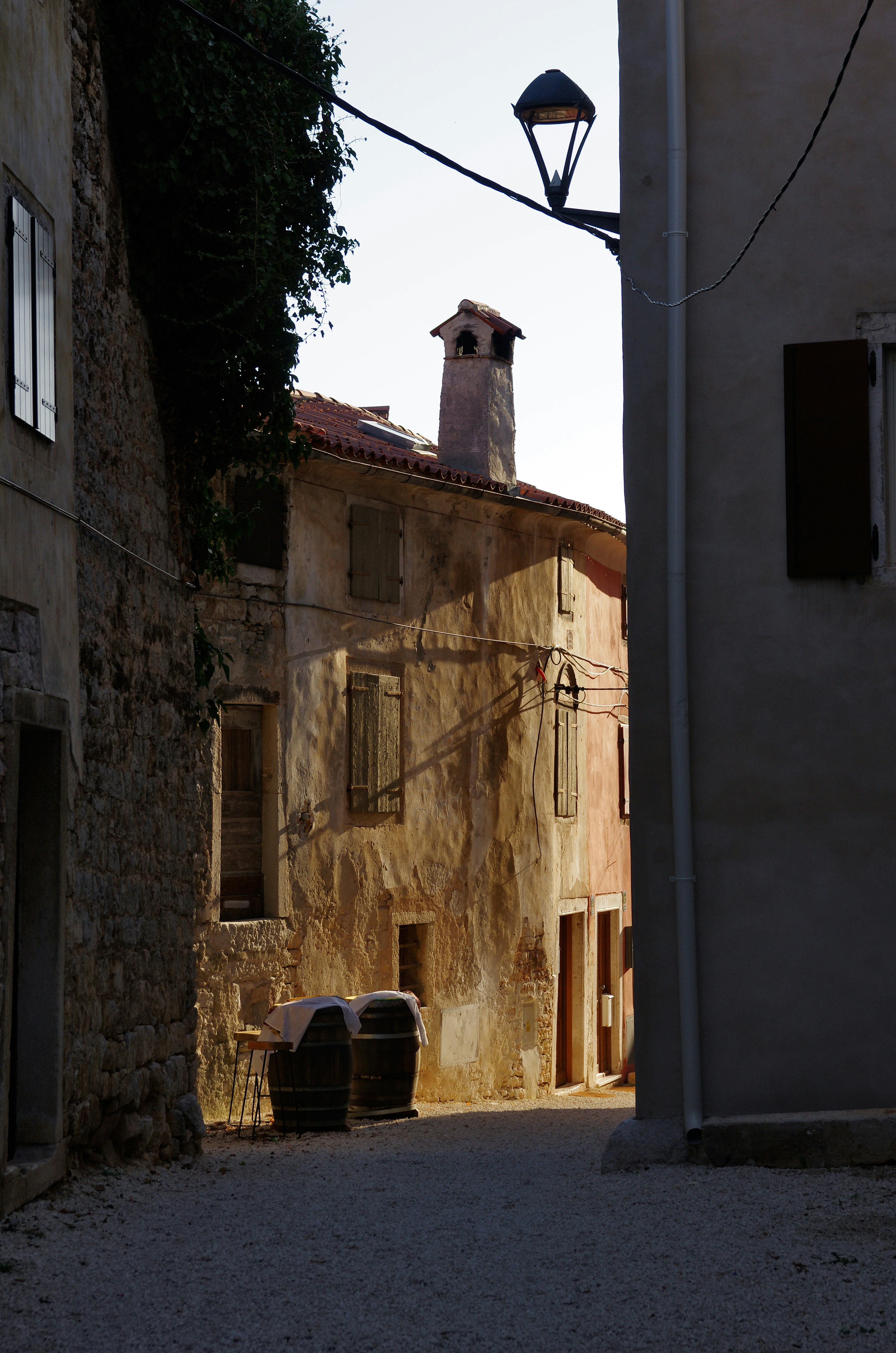 Sunlit Calle Through a Walled Narrow Lane