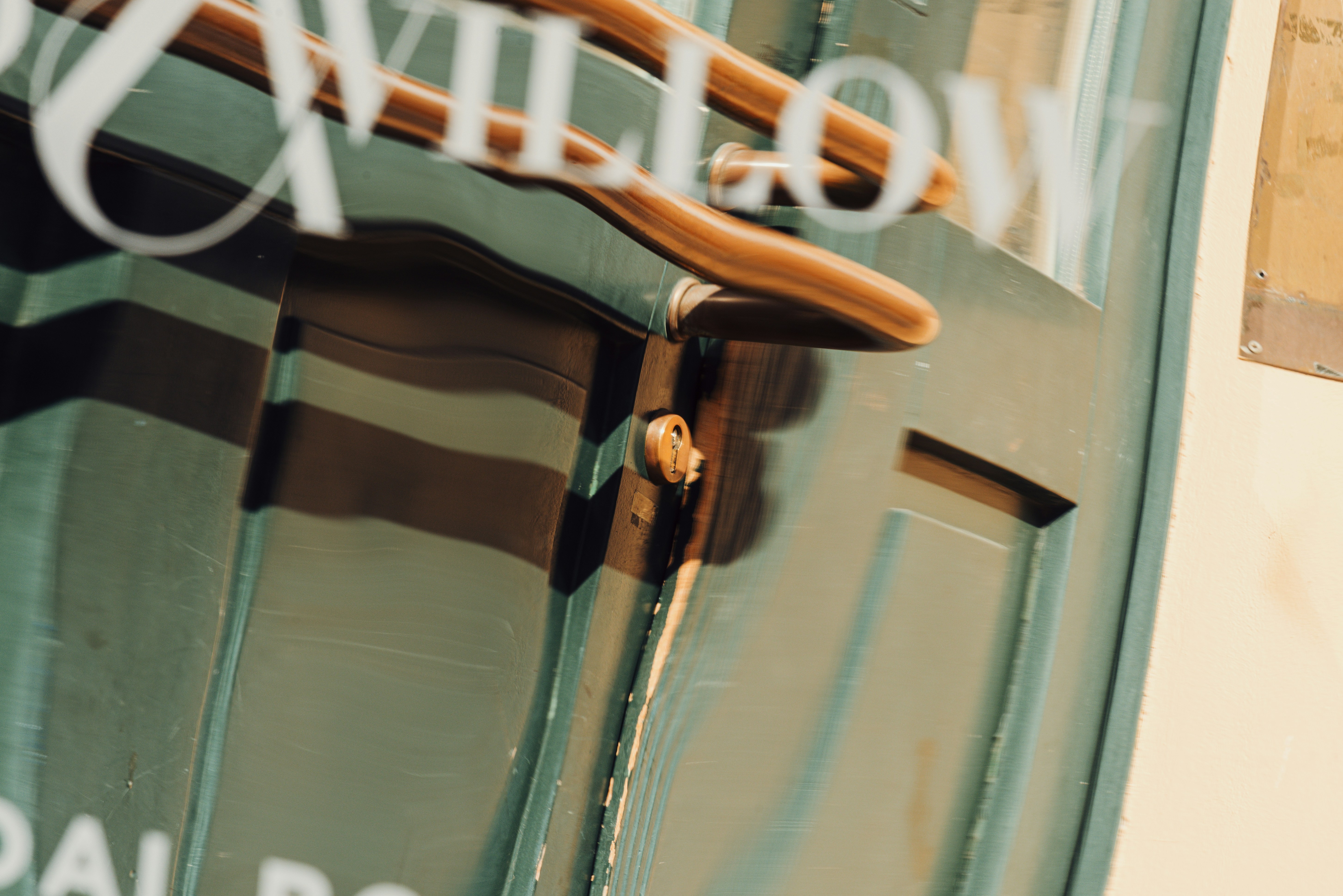 Pastel Green Doorway: A Tilted Glimpse into a Quiet Street