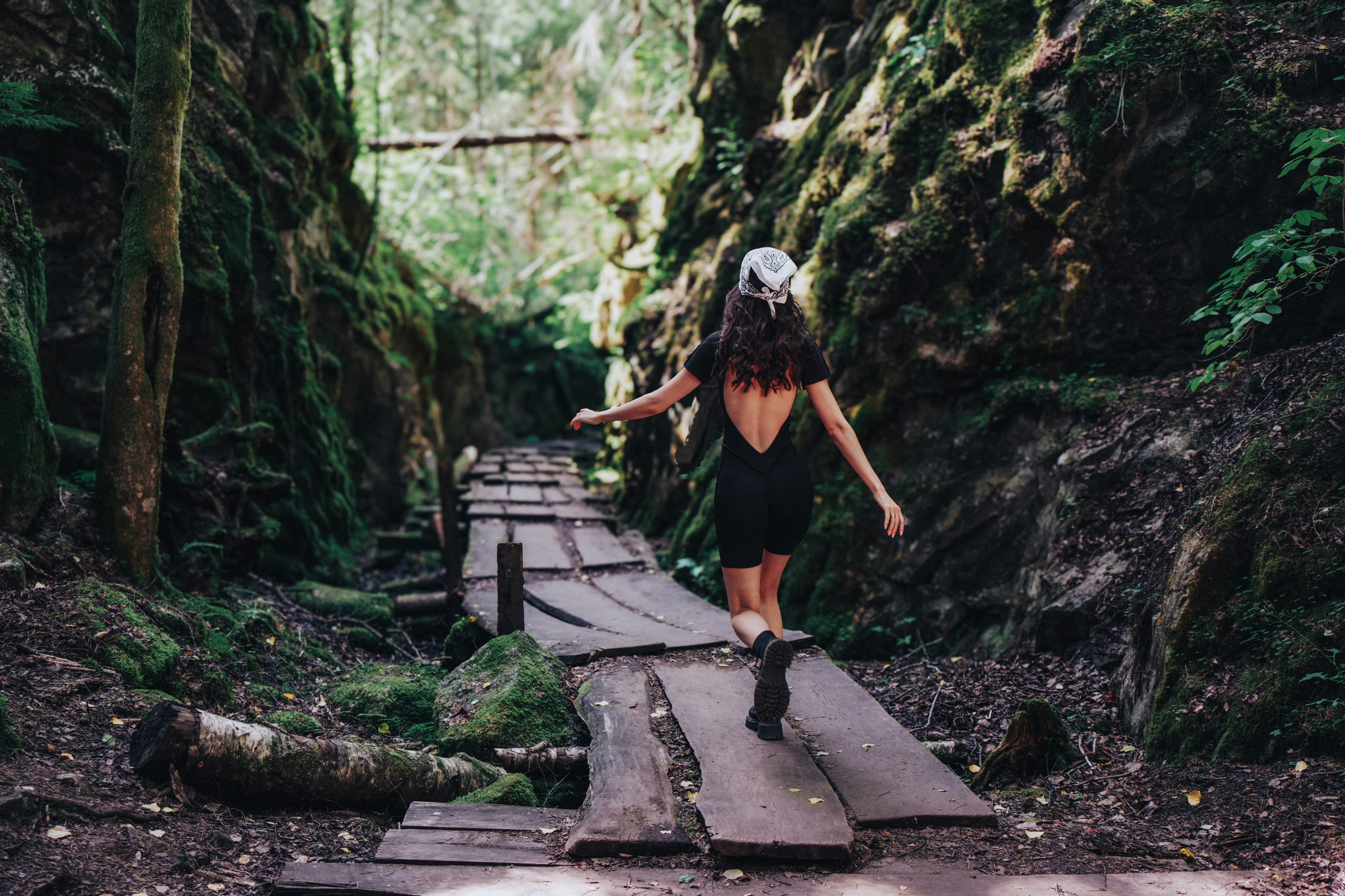 Pole-Bridge Echoes: A Wanderer Balances on a Rain-Washed Woodland Bridge