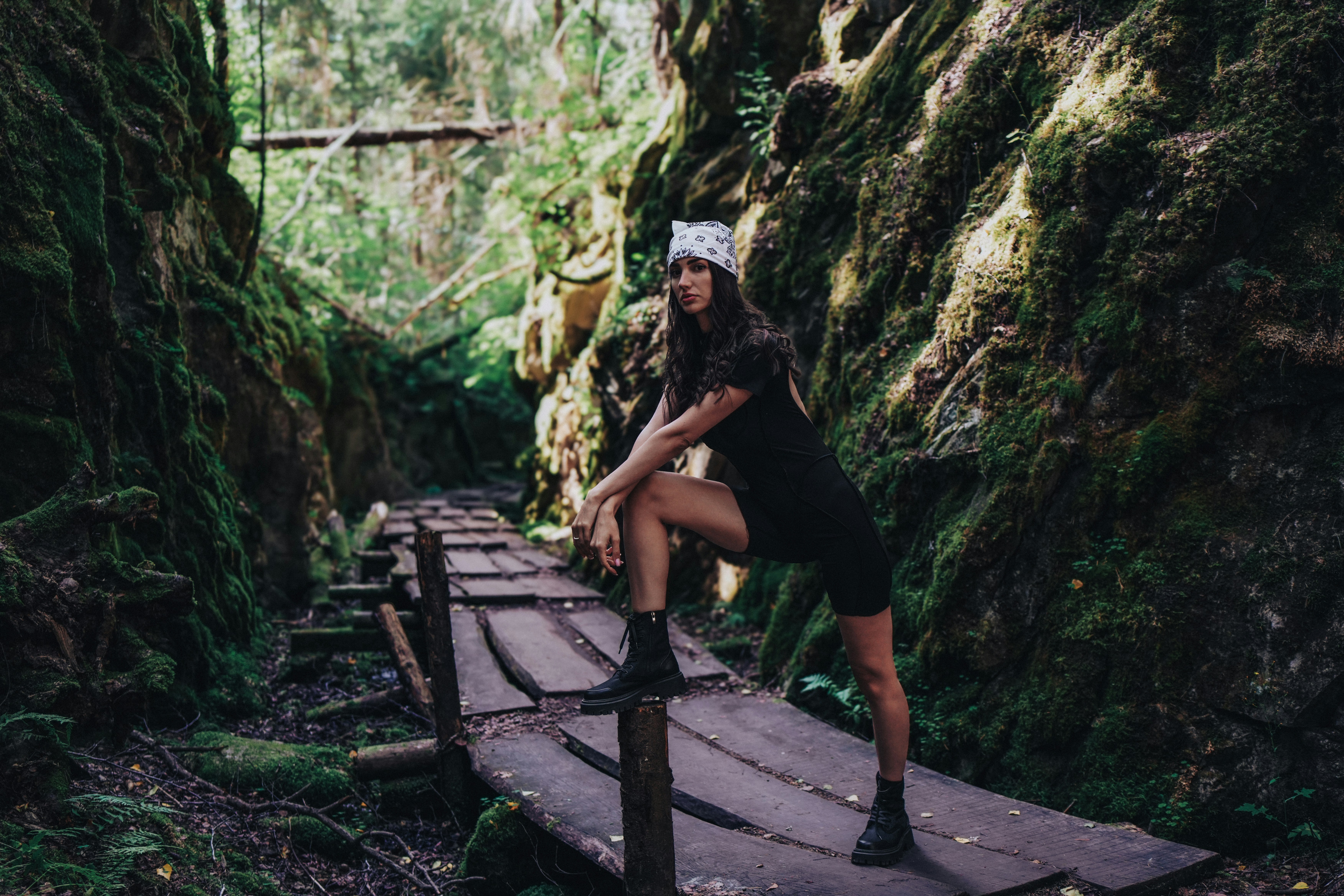 Traveler on a Mossy Canyon Bridge
