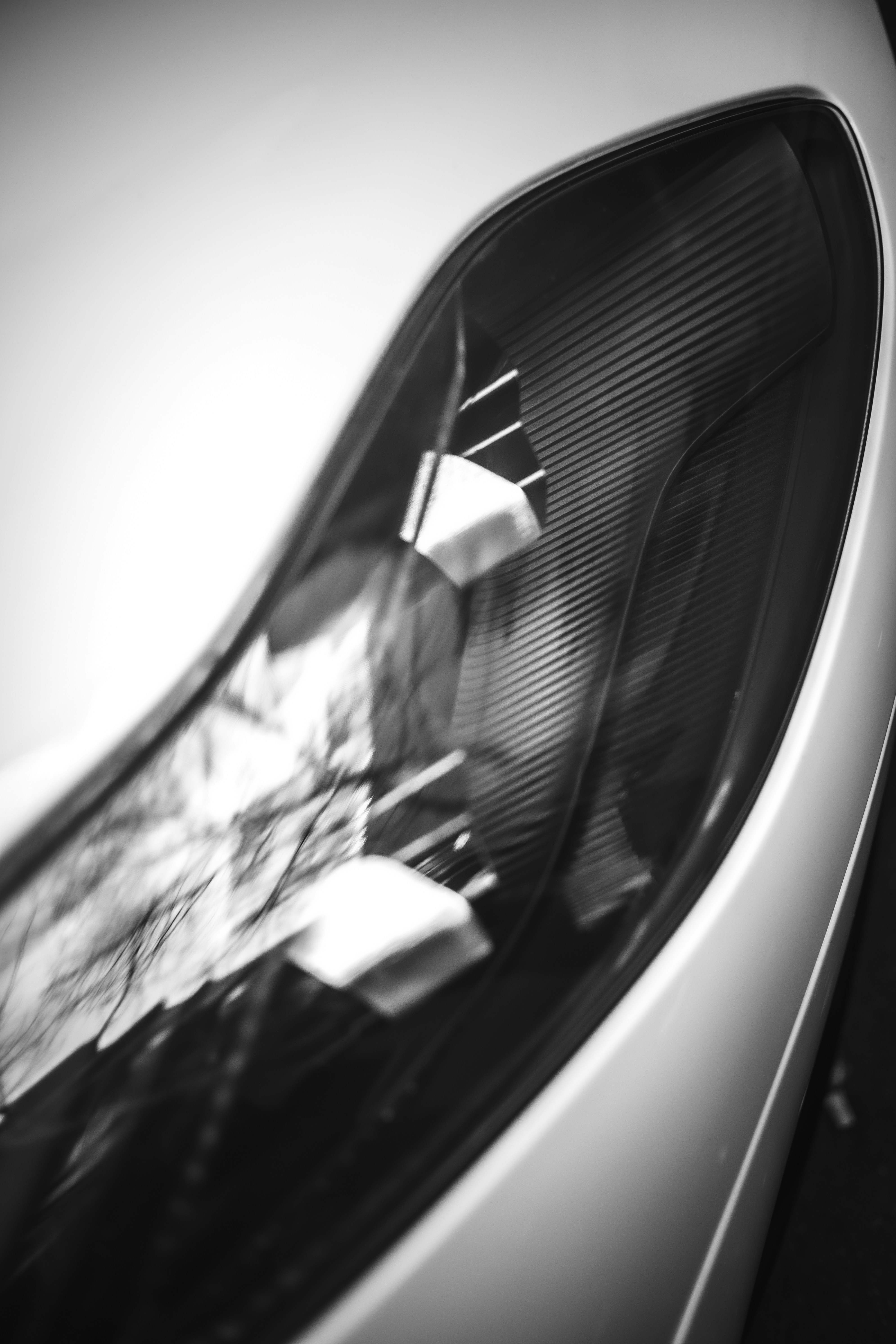 Monochrome Headlight: Close-Up of a Car Headlamp's Curved Glass