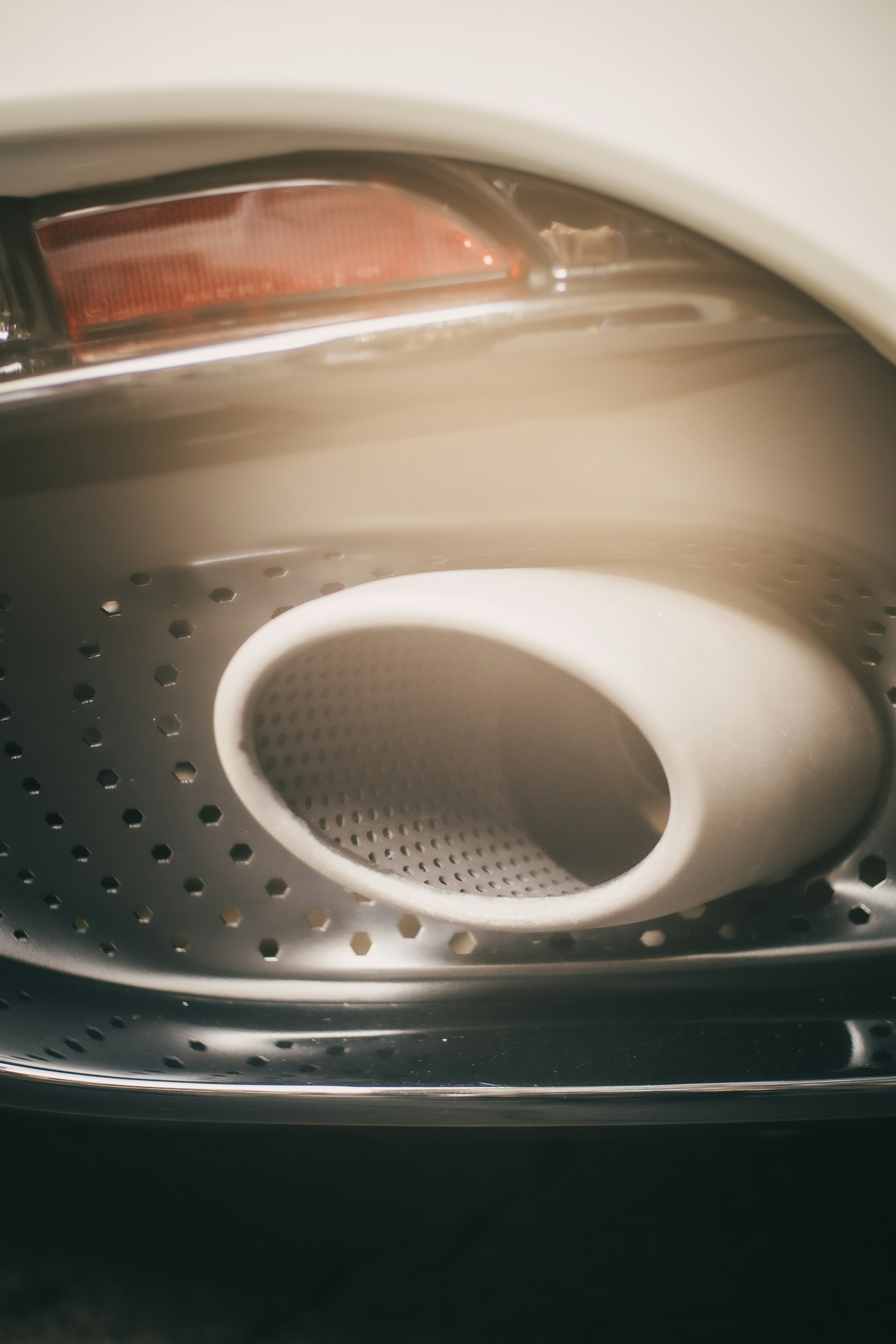 Industrial Focus: The Car Exhaust Port in Soft Evening Light