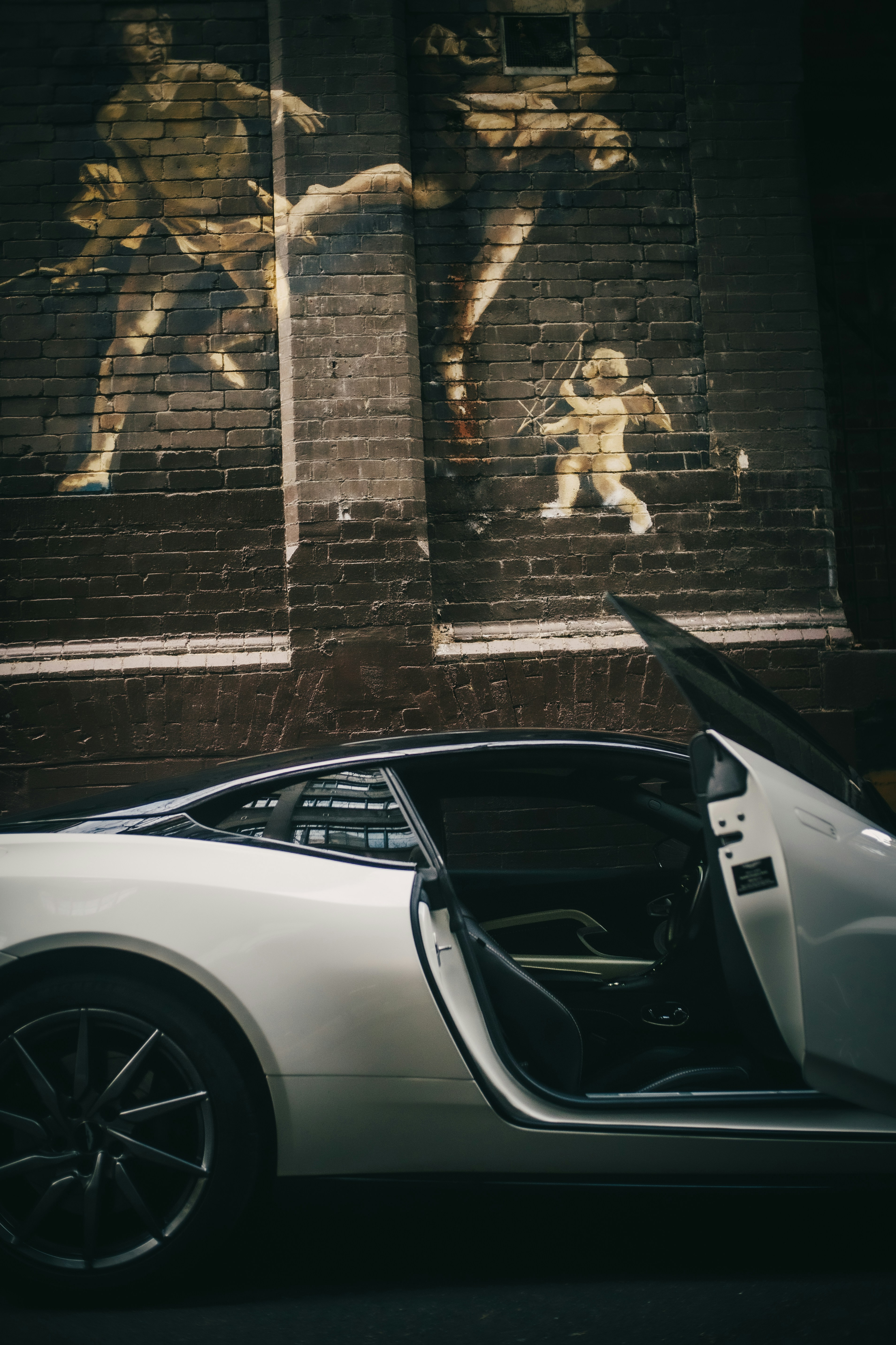 A Lidded Sunset: Malachi’s Car Paused Before Murals