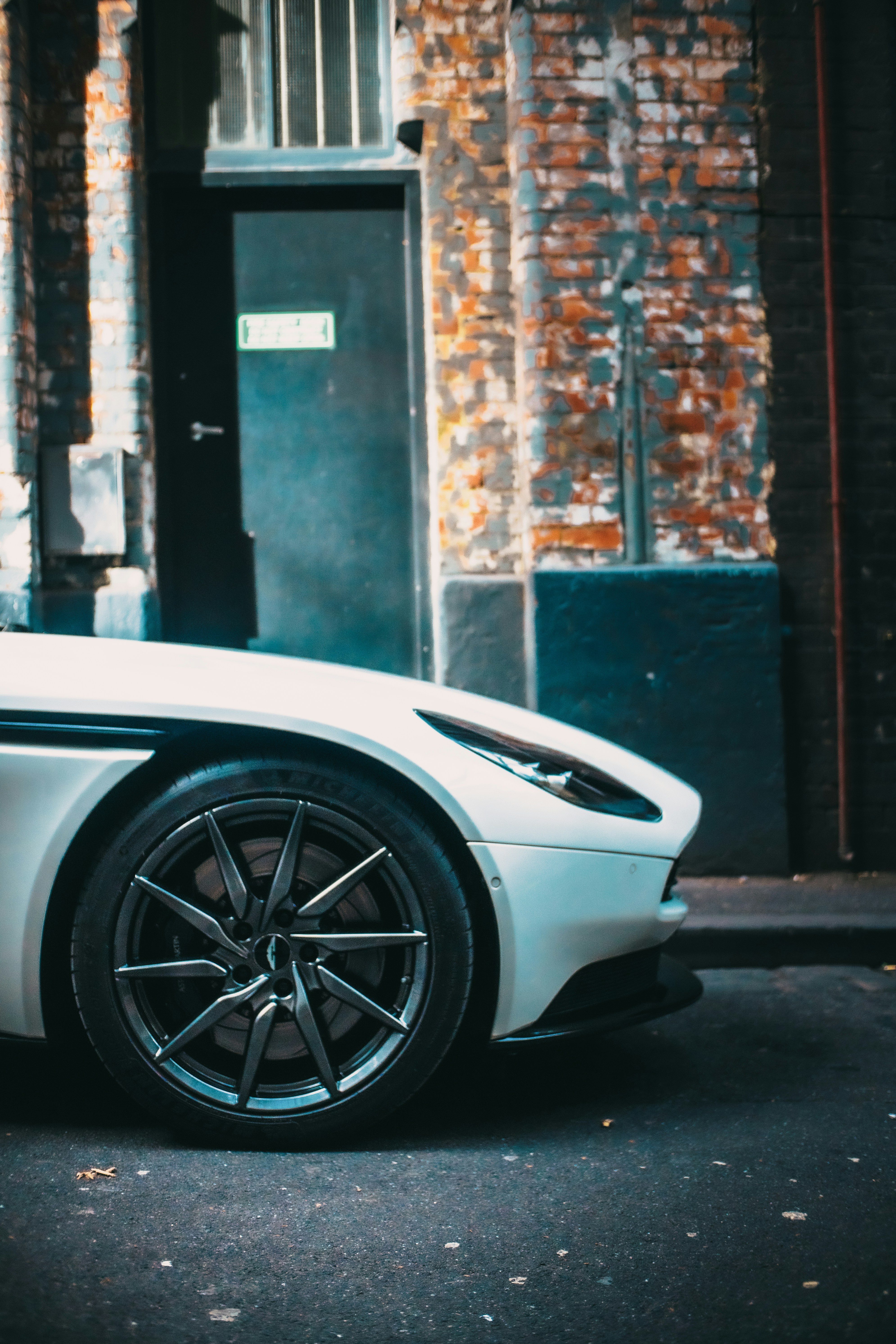 Low-Angle Glance: The White Derby at a Quiet Alley
