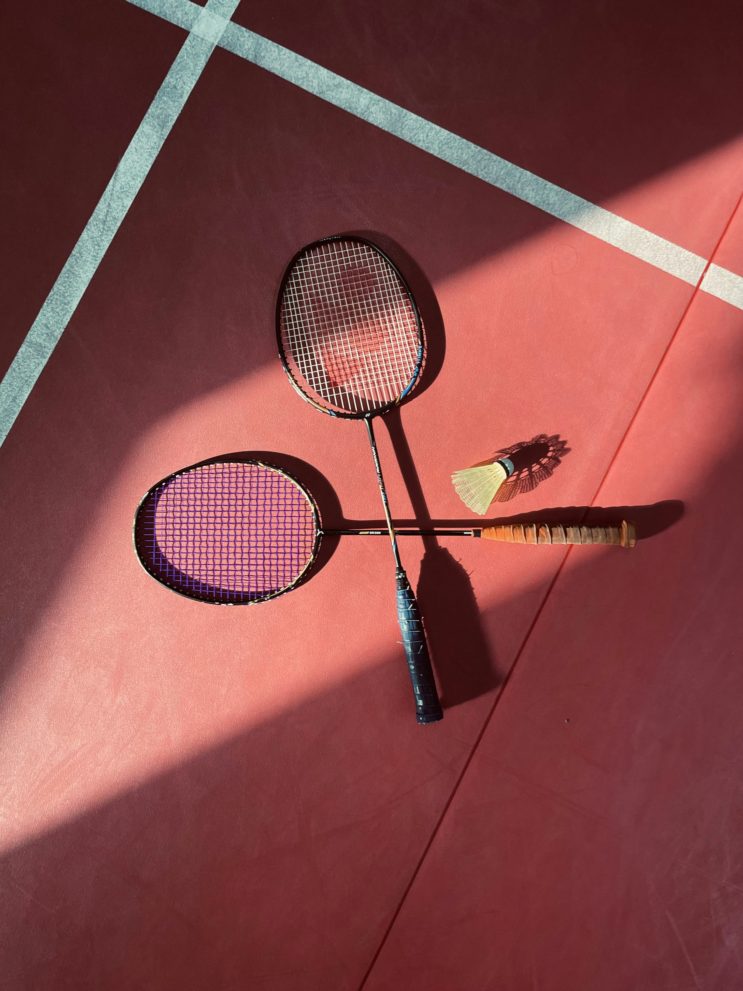 Disrupted Shadow Play: Rackets Rest on a Painted Court