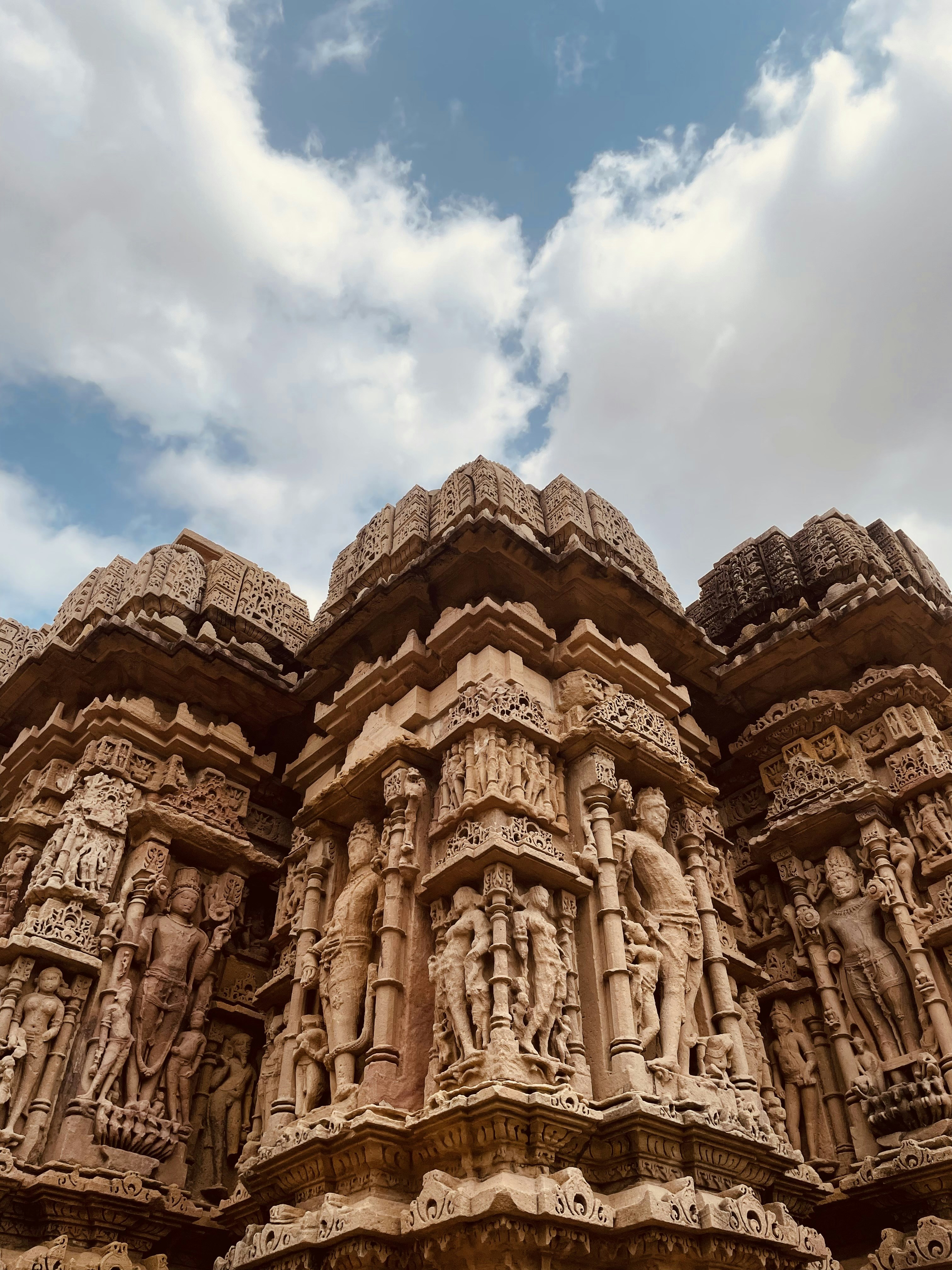 Carved Monoliths Under a Sky of Clouds