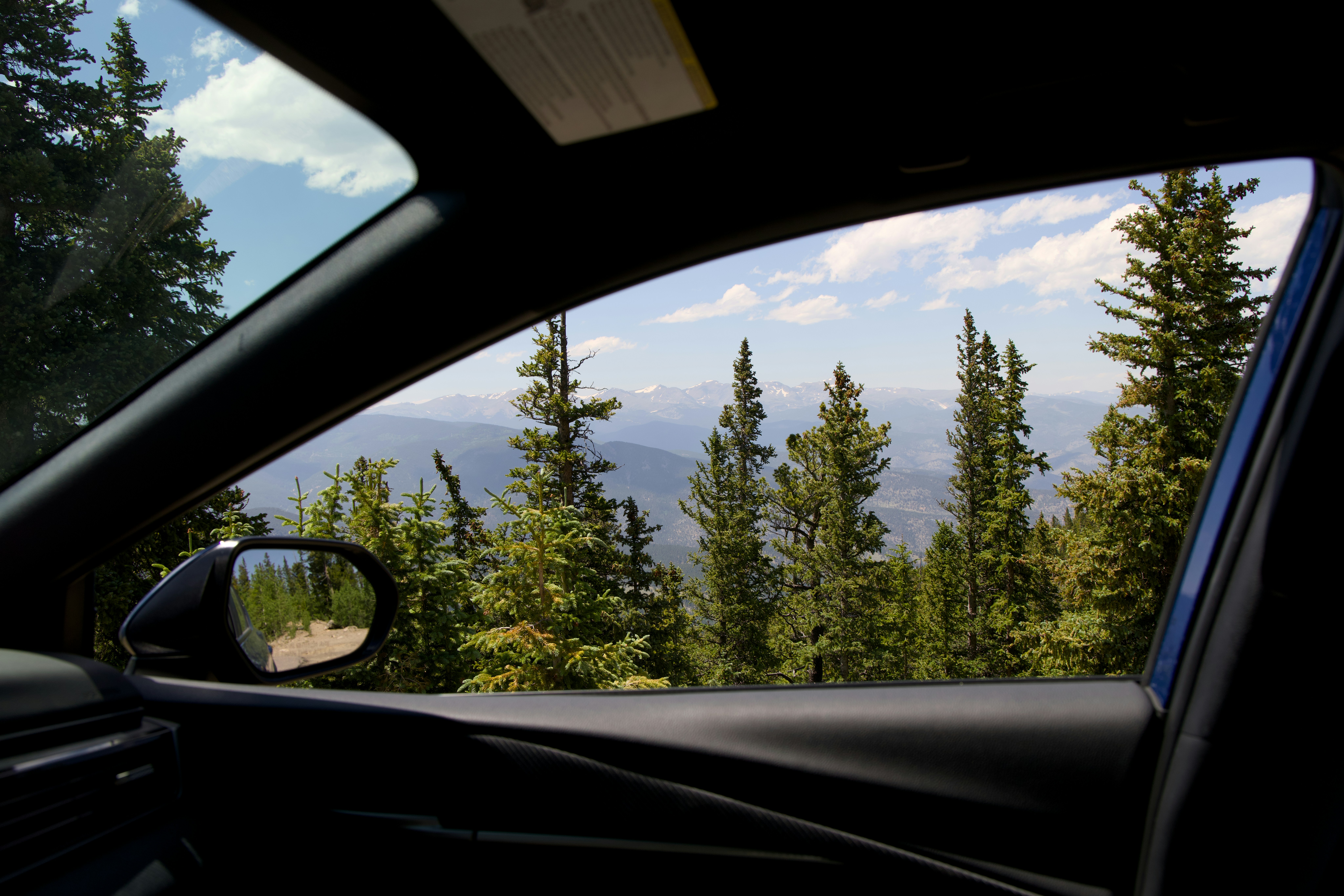 Windowed Alps: A Calm Car Interior Framing a Mountain Ridge