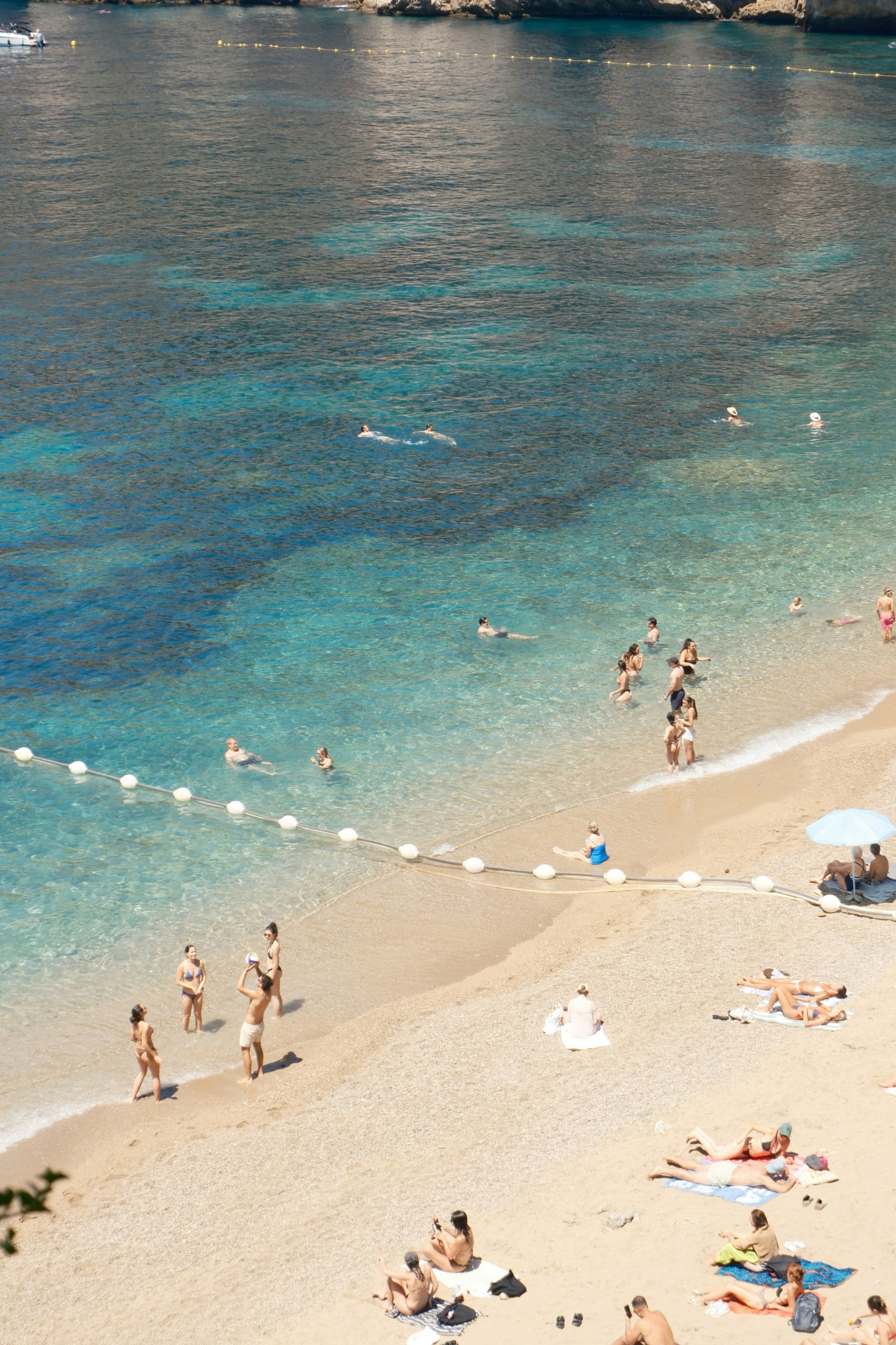 Azure Beach: Sunlit Tide and Lounging Silhouettes