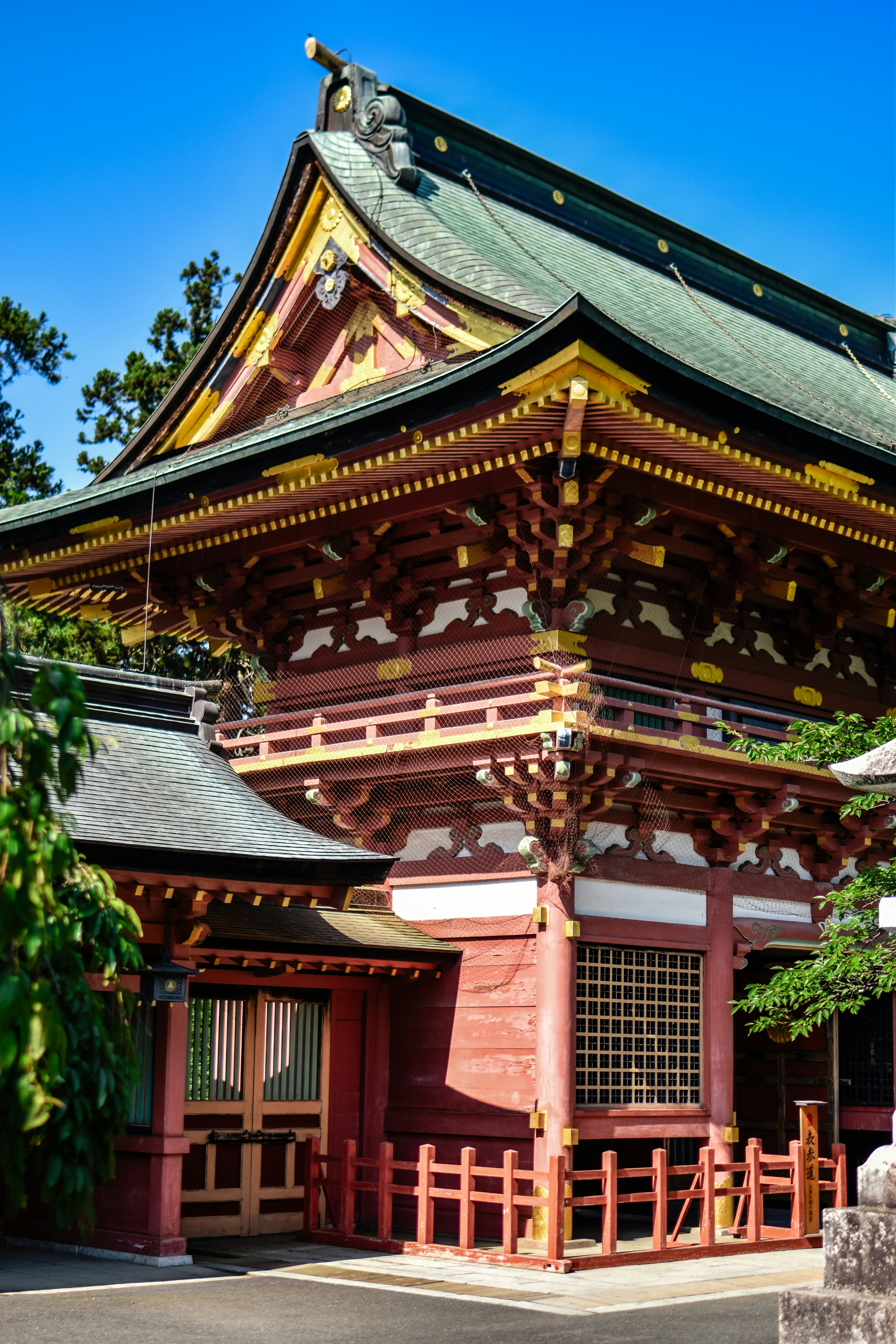 Temple Rooflines and Carved Timberwork in Sunlit Red Pavilion