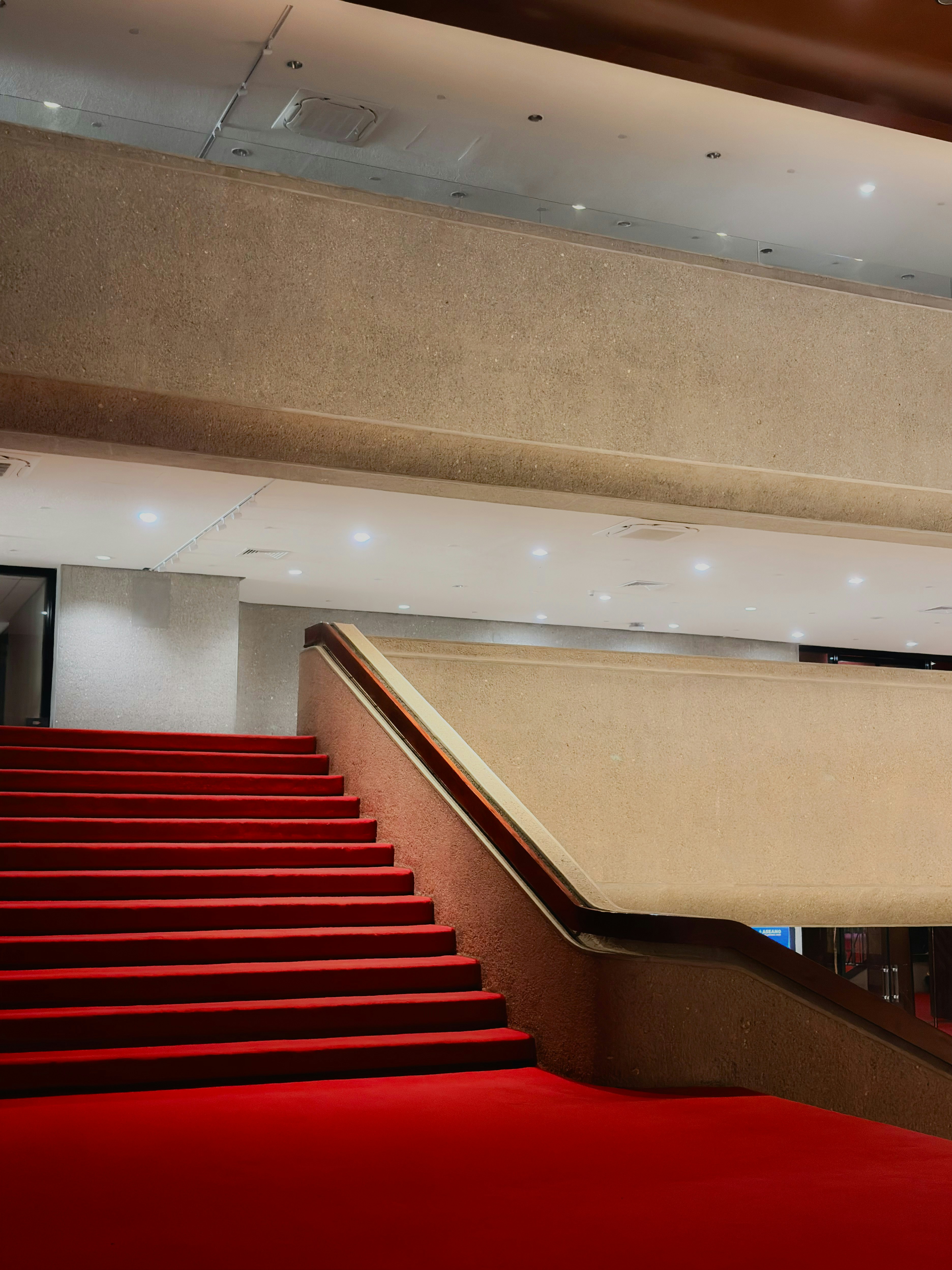 Red Carpet Ascent: A Grand Entrance in Quiet Limestone Halls