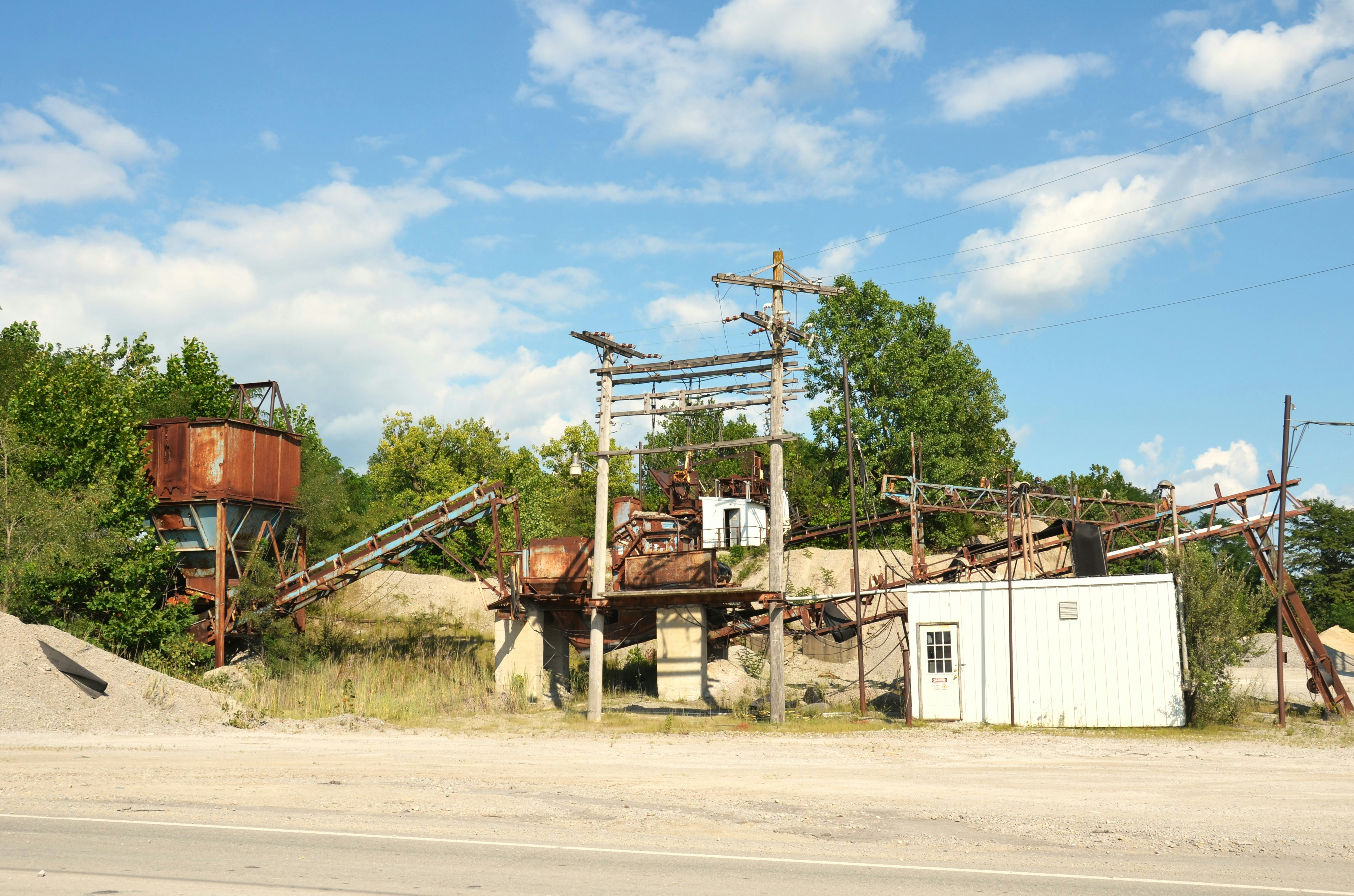 Rusting Monolith: An abandoned ore mill under a bright sky