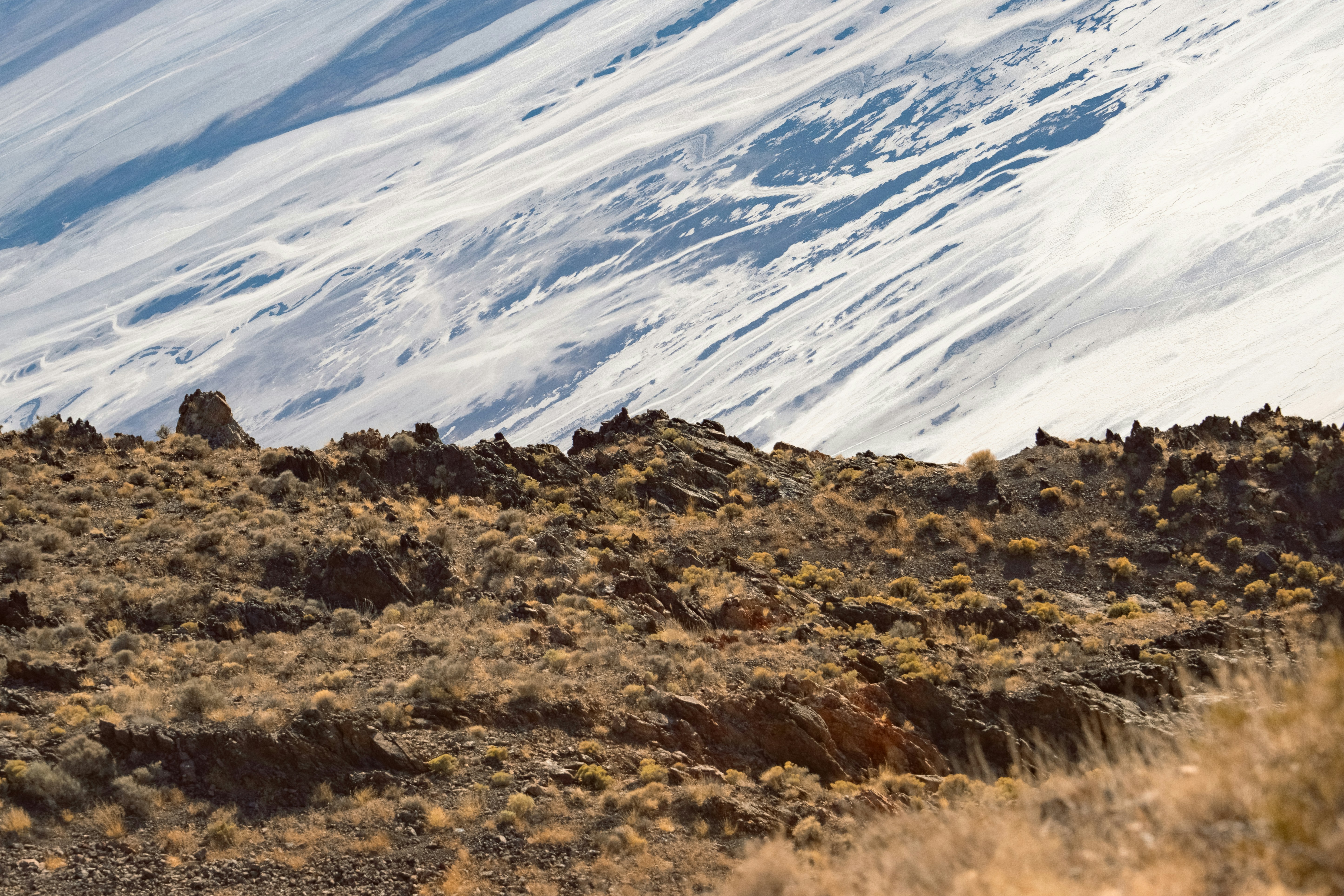 Desert-Rim Silhouette Beneath a Glacial Slope