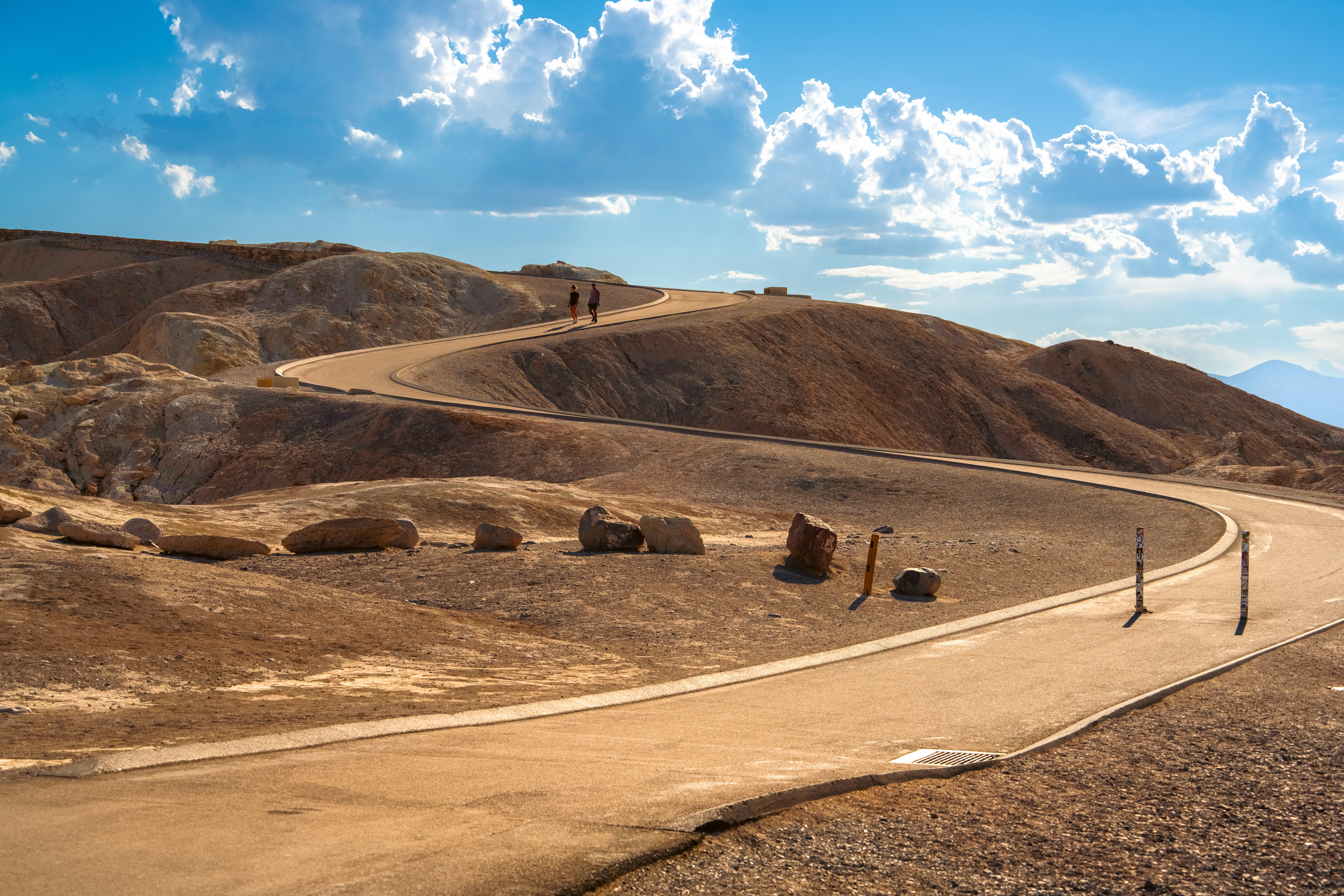 Desert Road Carved Through Sunlit Hills