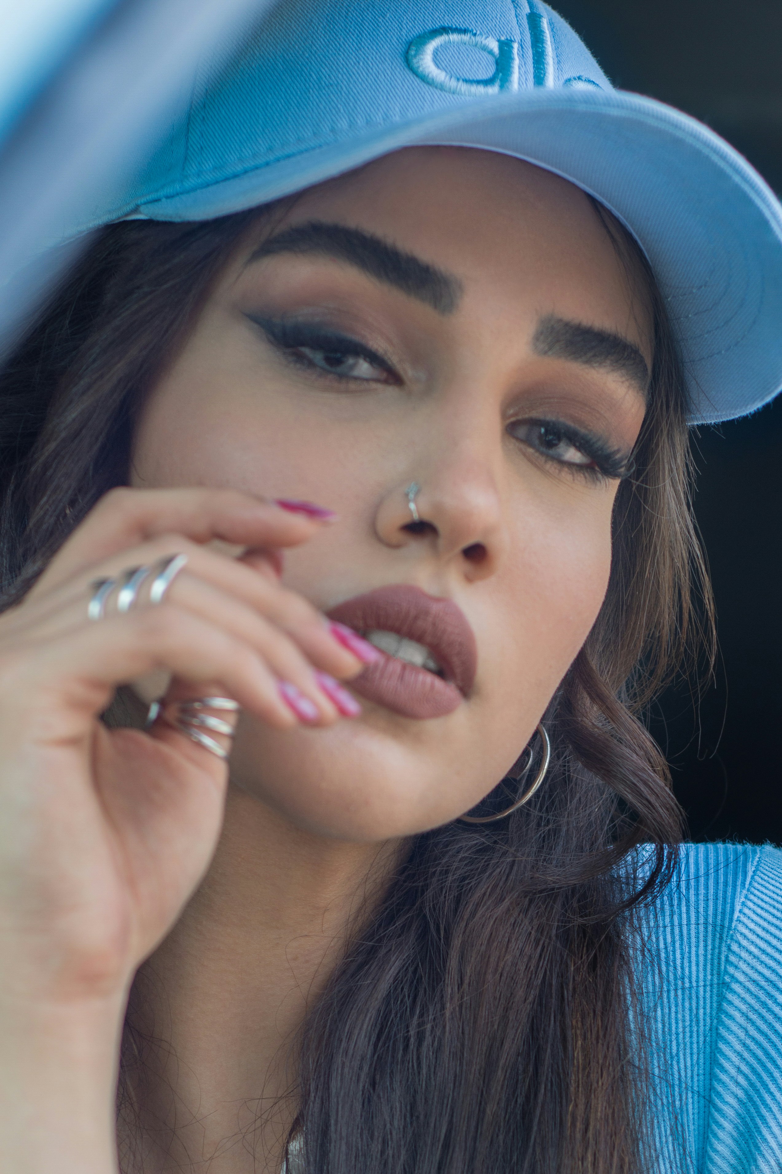 Blue Cap and Velvet Gaze: A Close Portrait of Confidence