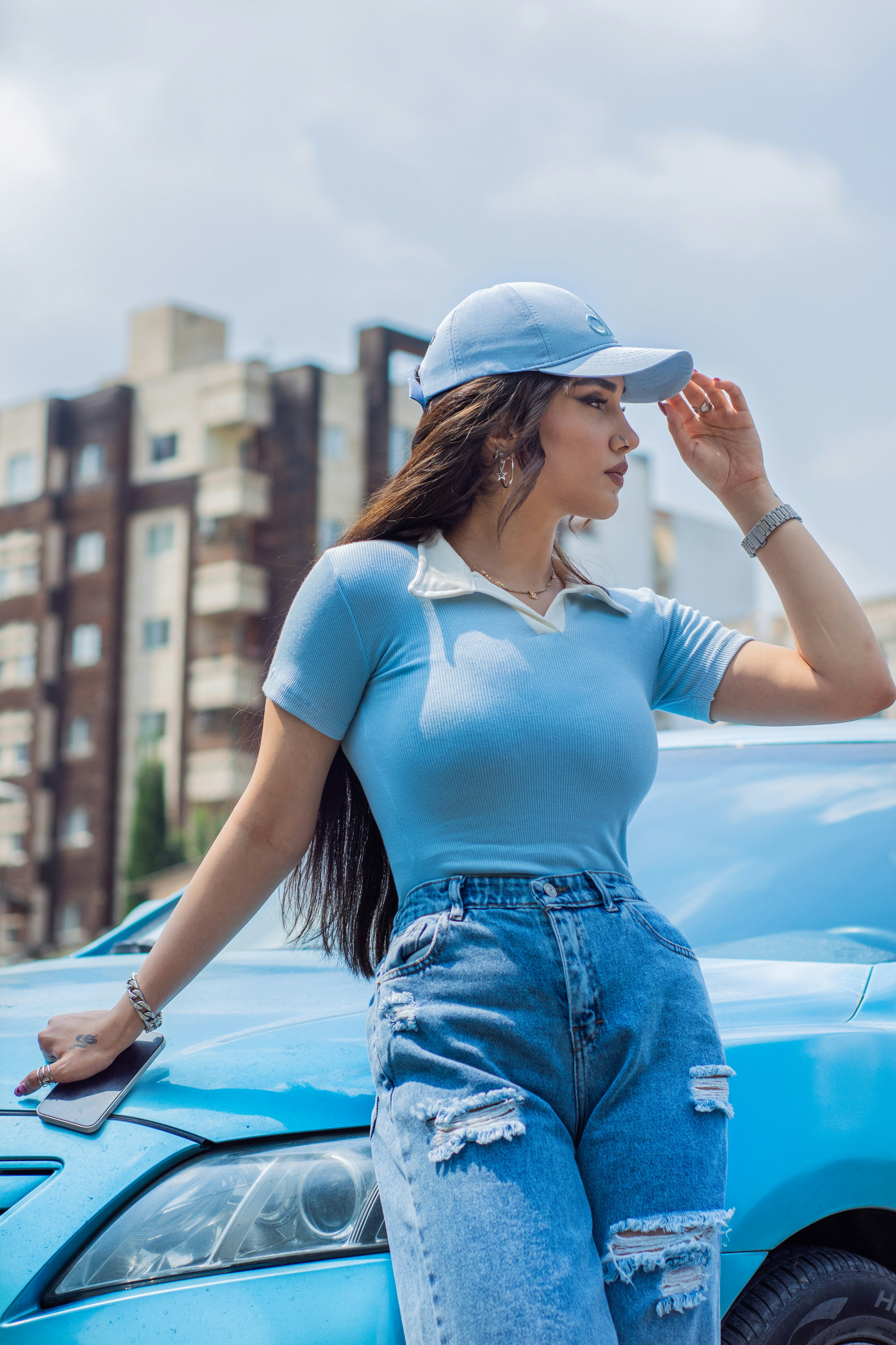 Blue Polo, Blue Sky: A poised moment beside a vintage blue car