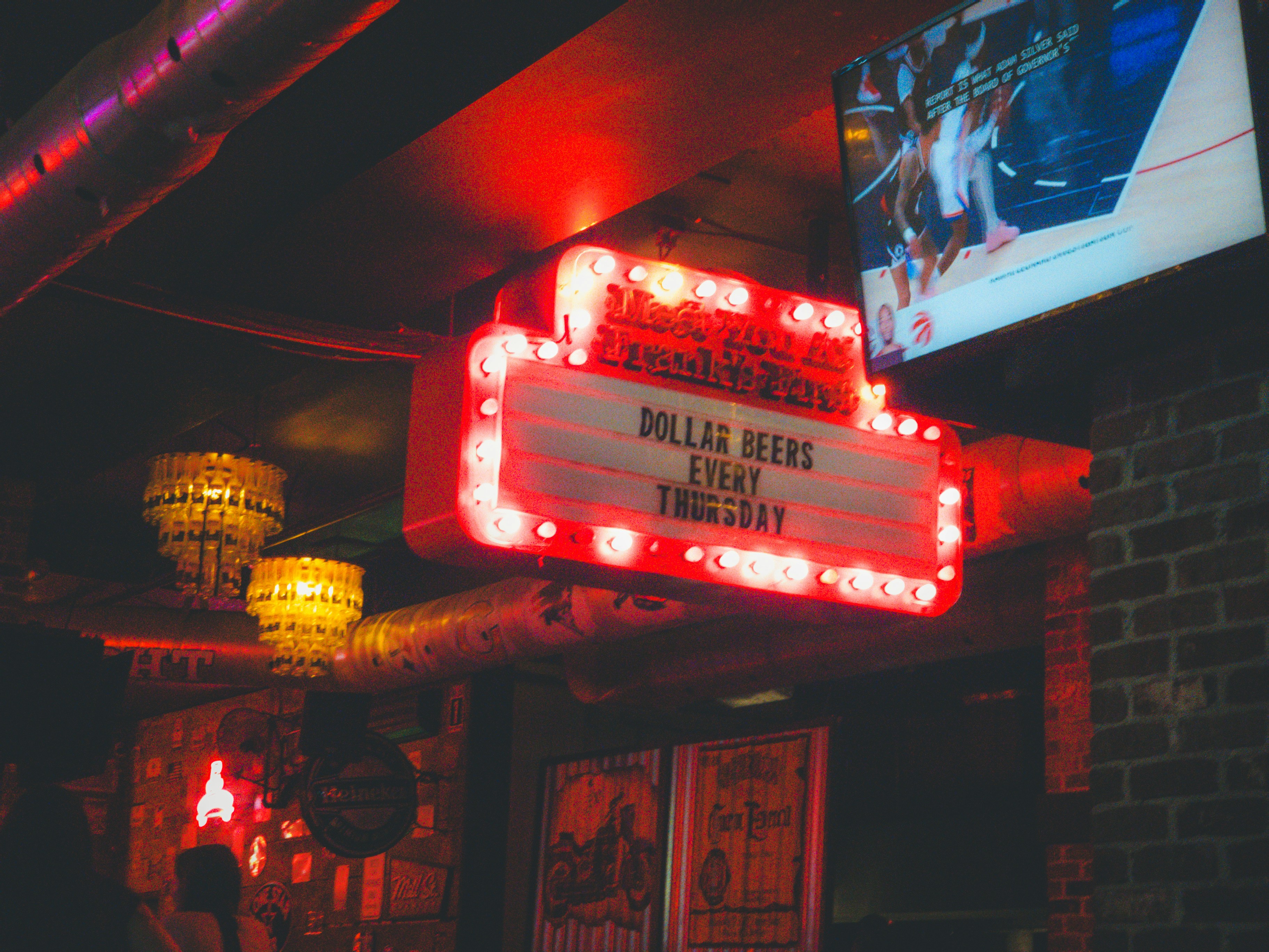 Neon Sign Glow Over a Dim Bar Corridor