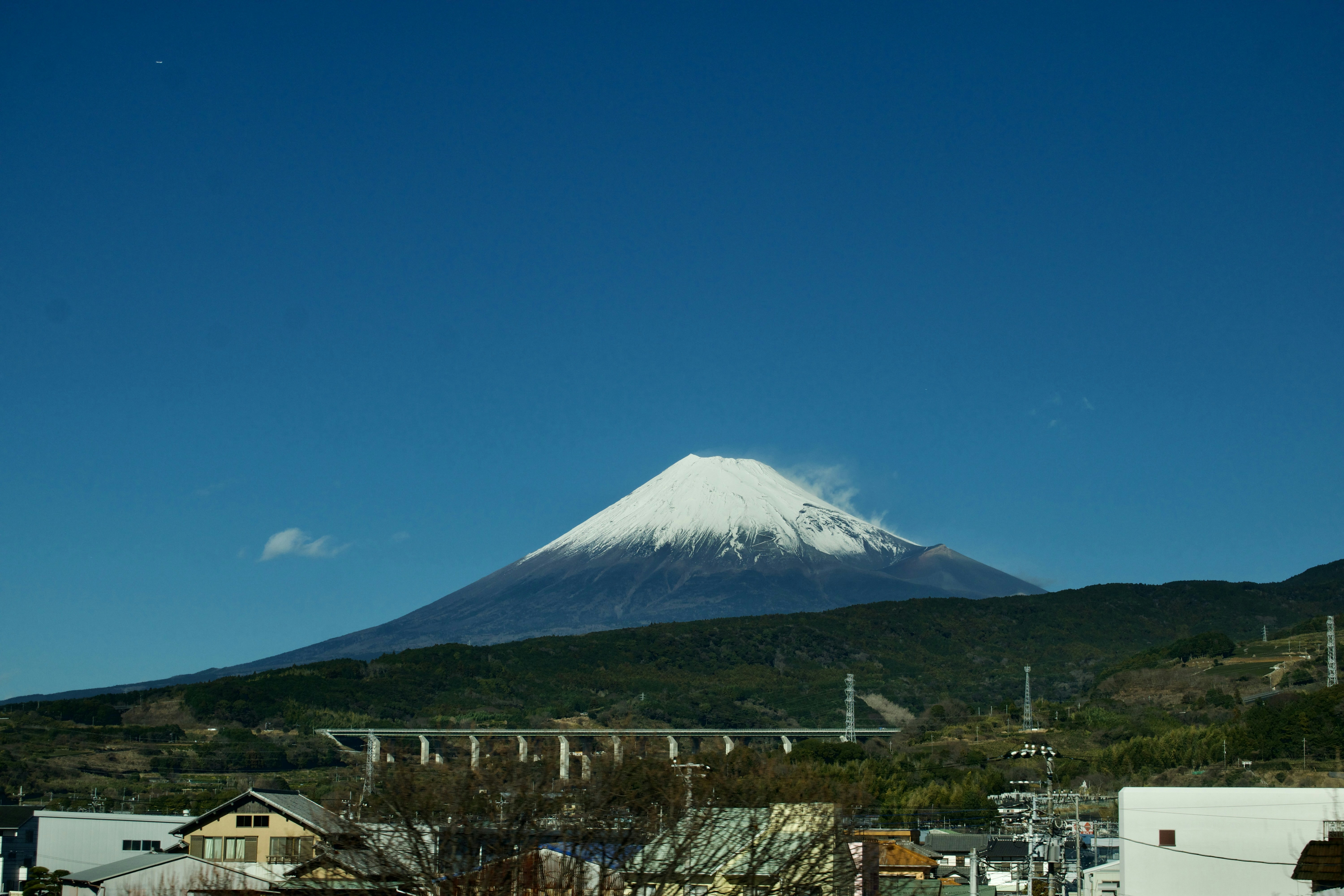 Snow-capped Peak Over Town Rooftops