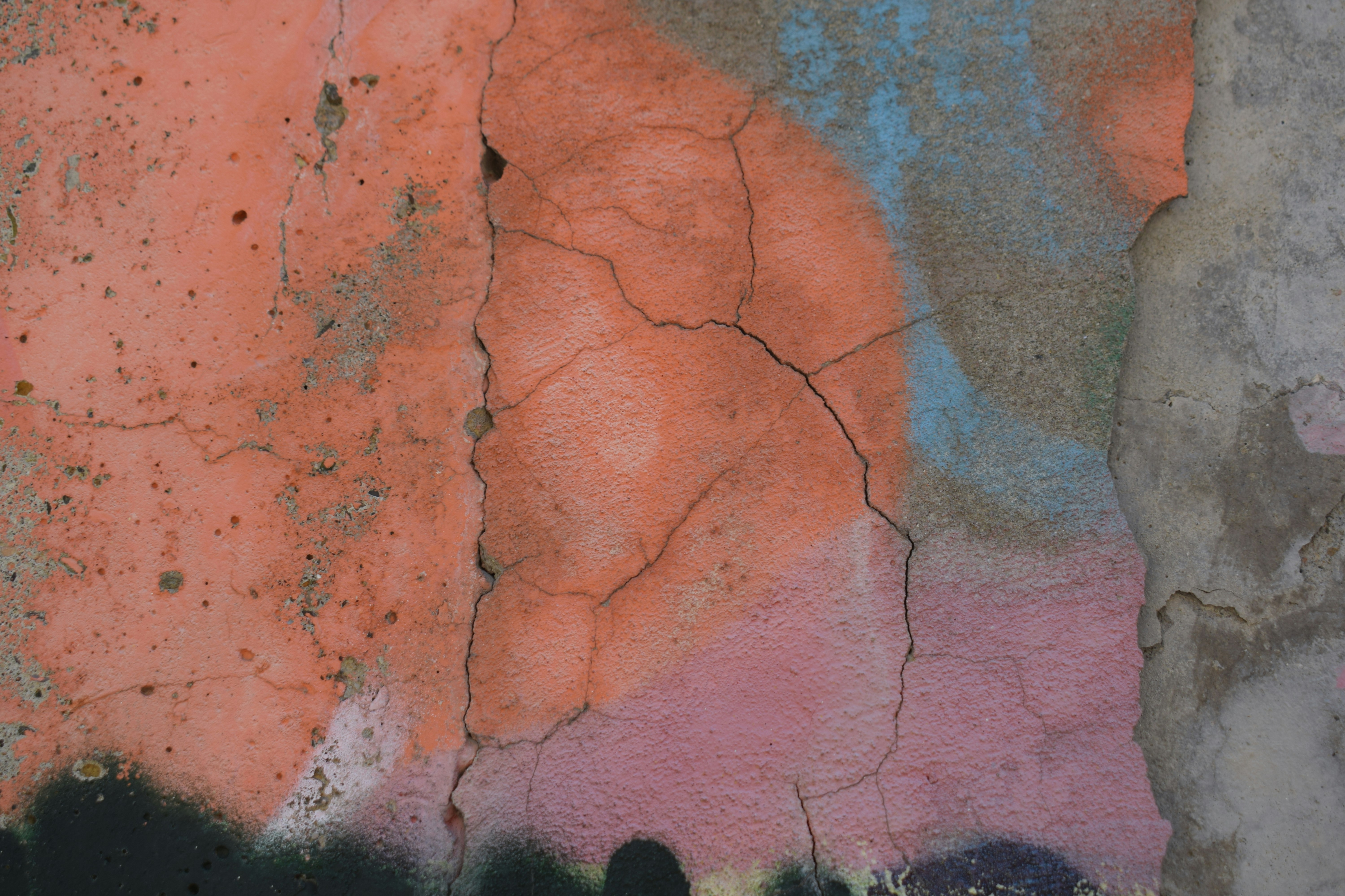 Cracked Fresco: A Weathered Wall in Multicolored Graffiti