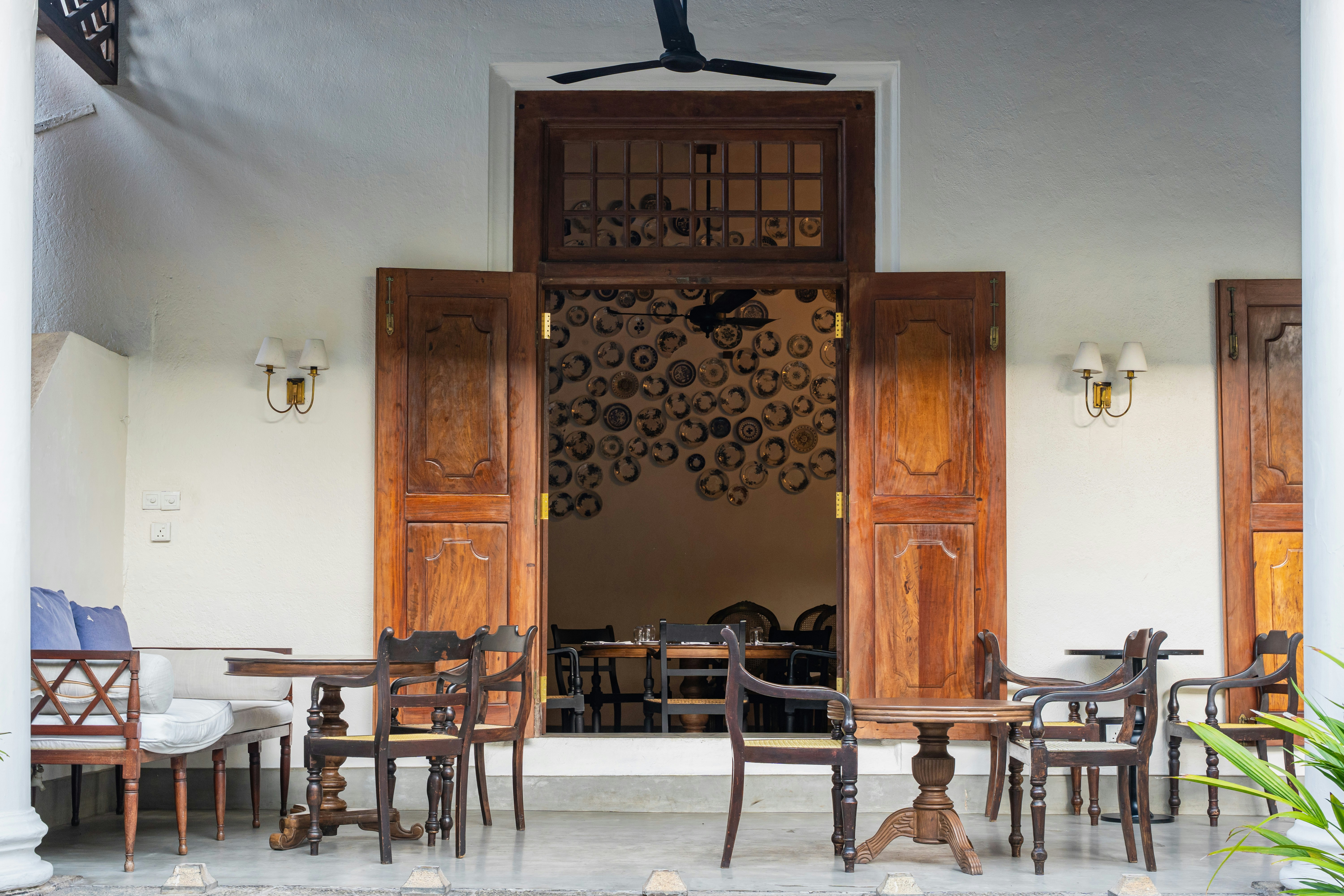 Open-air Café Terrace Framed by Carved Doors