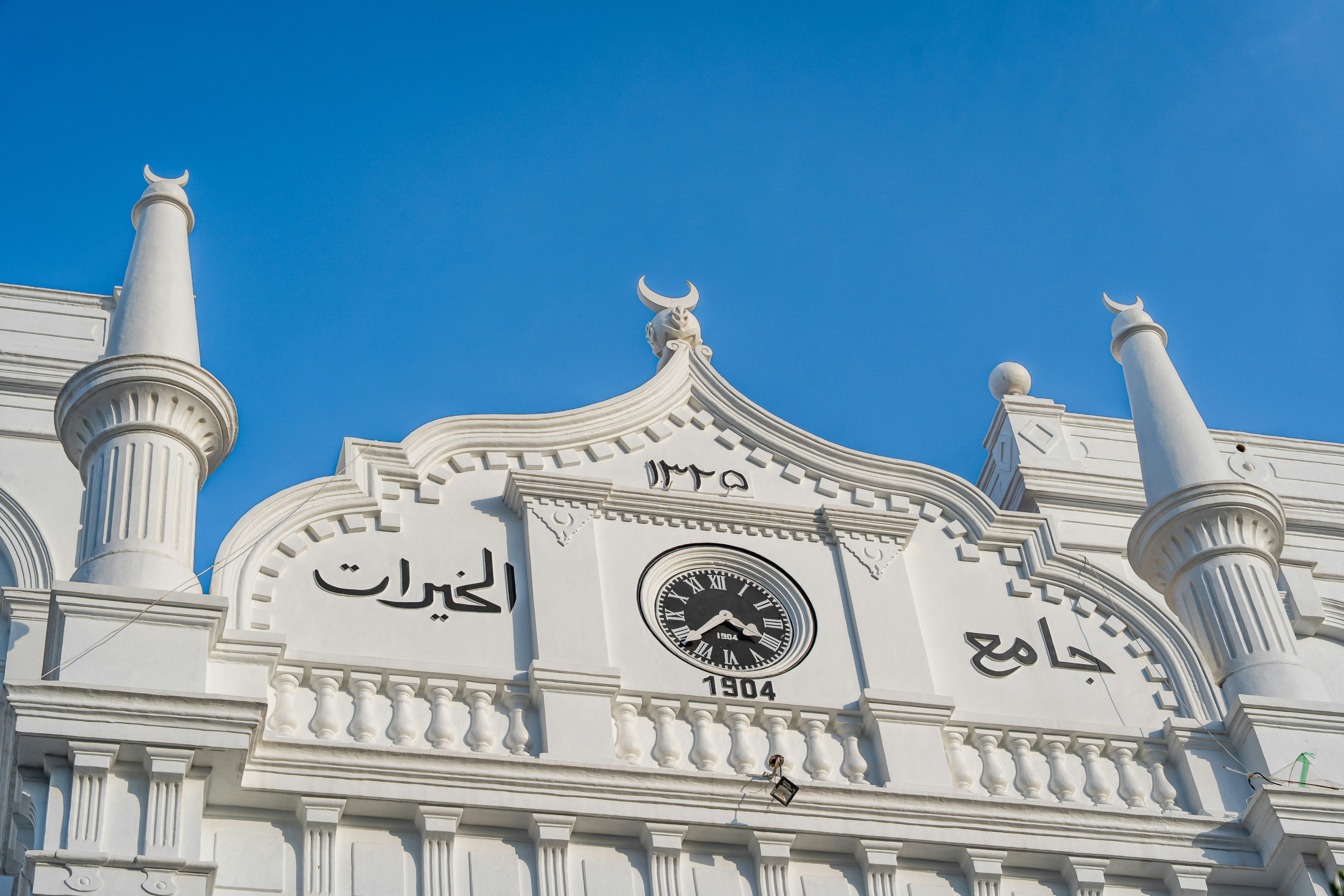 Ornate Clock Facade of a White Architectural Structure