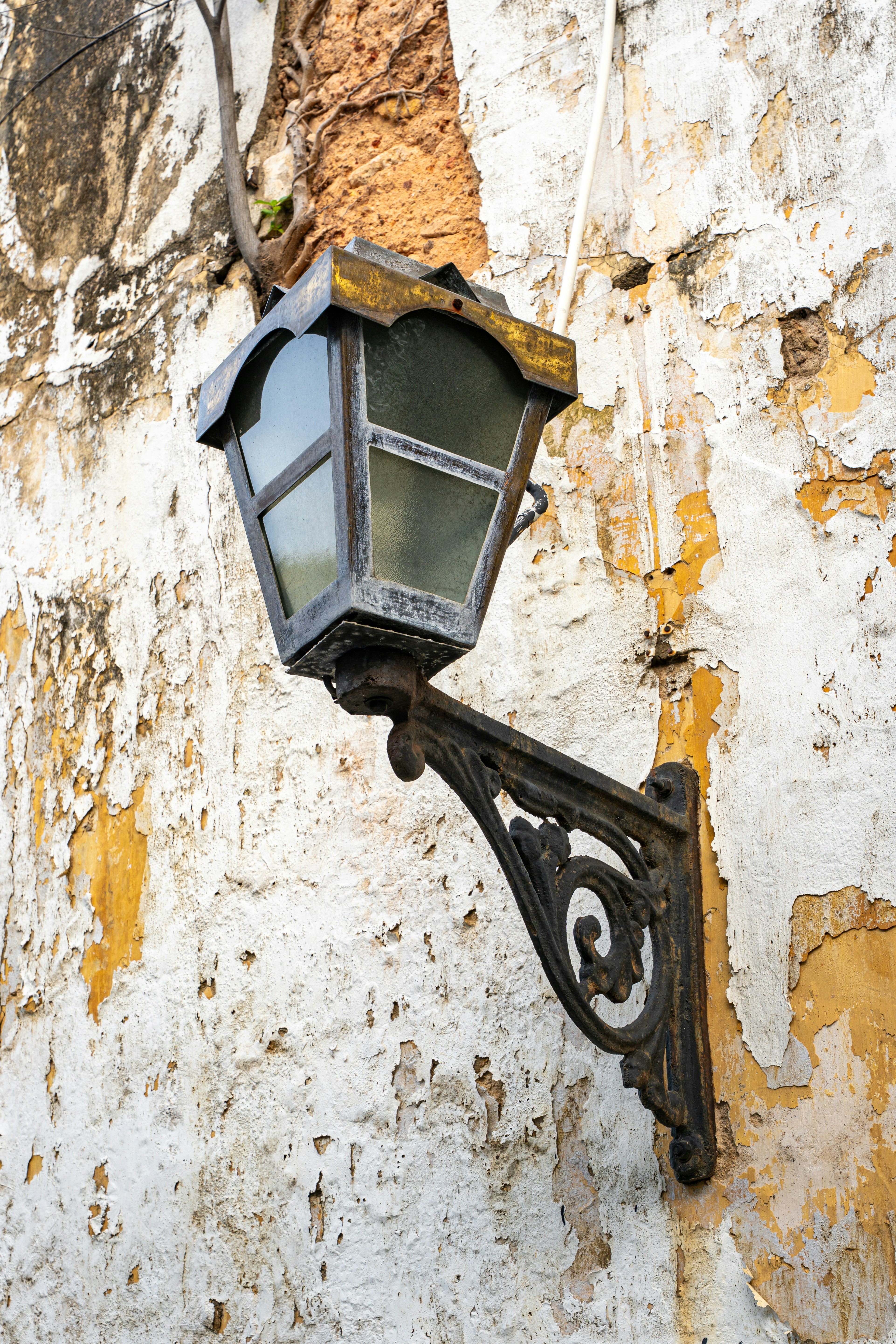 Old Lantern, Warm Wall: A Weathered Lamp Adorning a Crumbling Façade