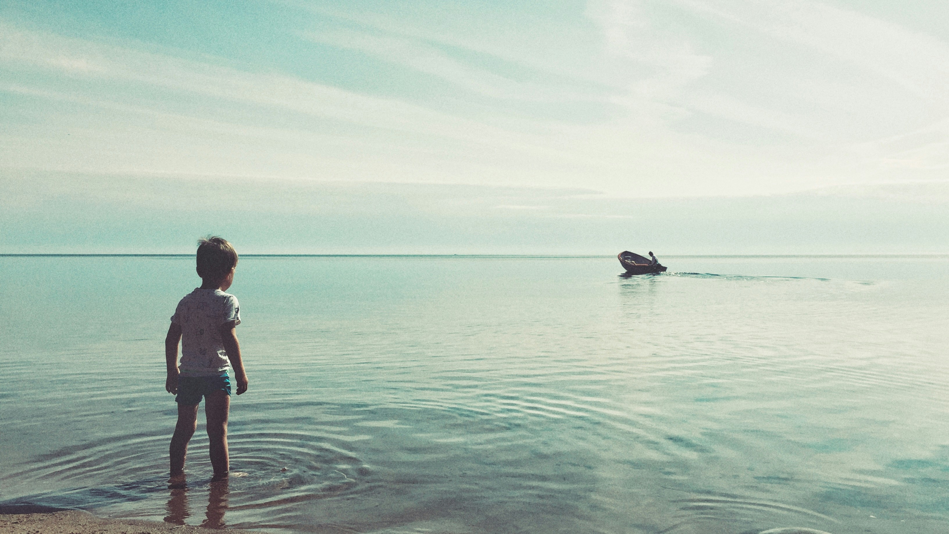 Shoreline Watcher: A Lone Child at the Horizon