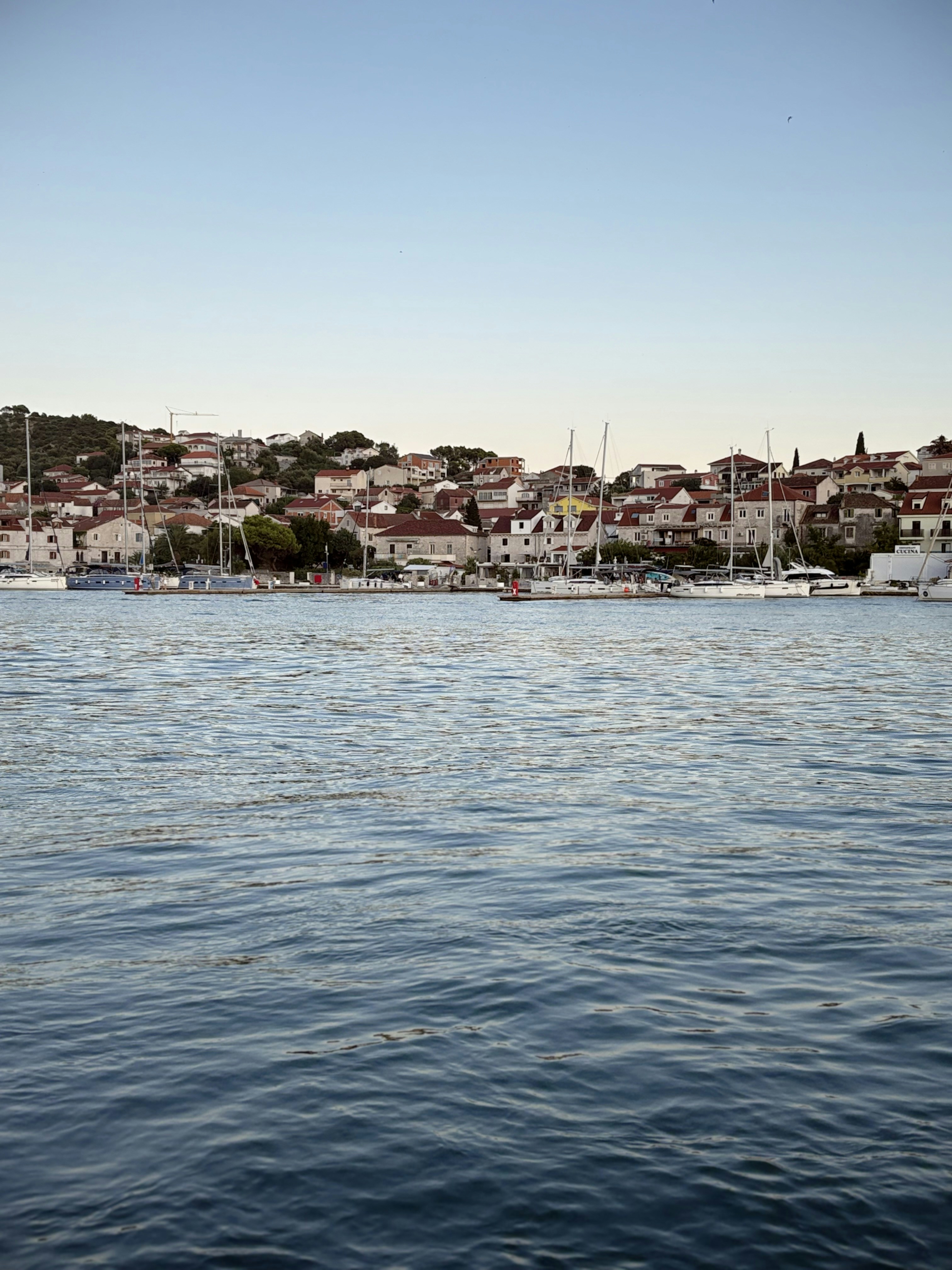 Coastal Village Boats and Red-Tiled Rooftops Beneath a Clear Sky