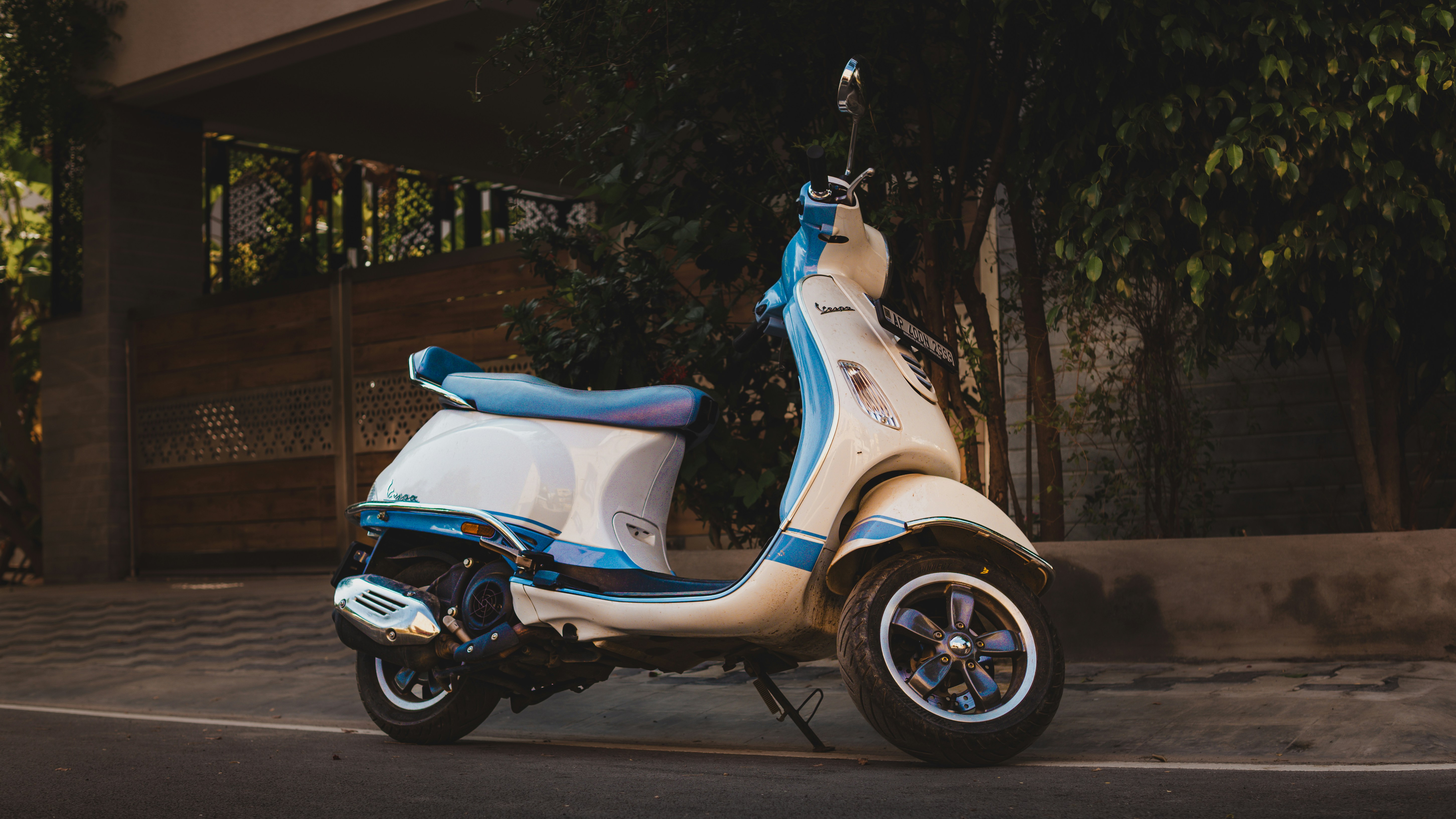 Pastel Ride: A Cream-and-Blue Vespa Resting by the Curb
