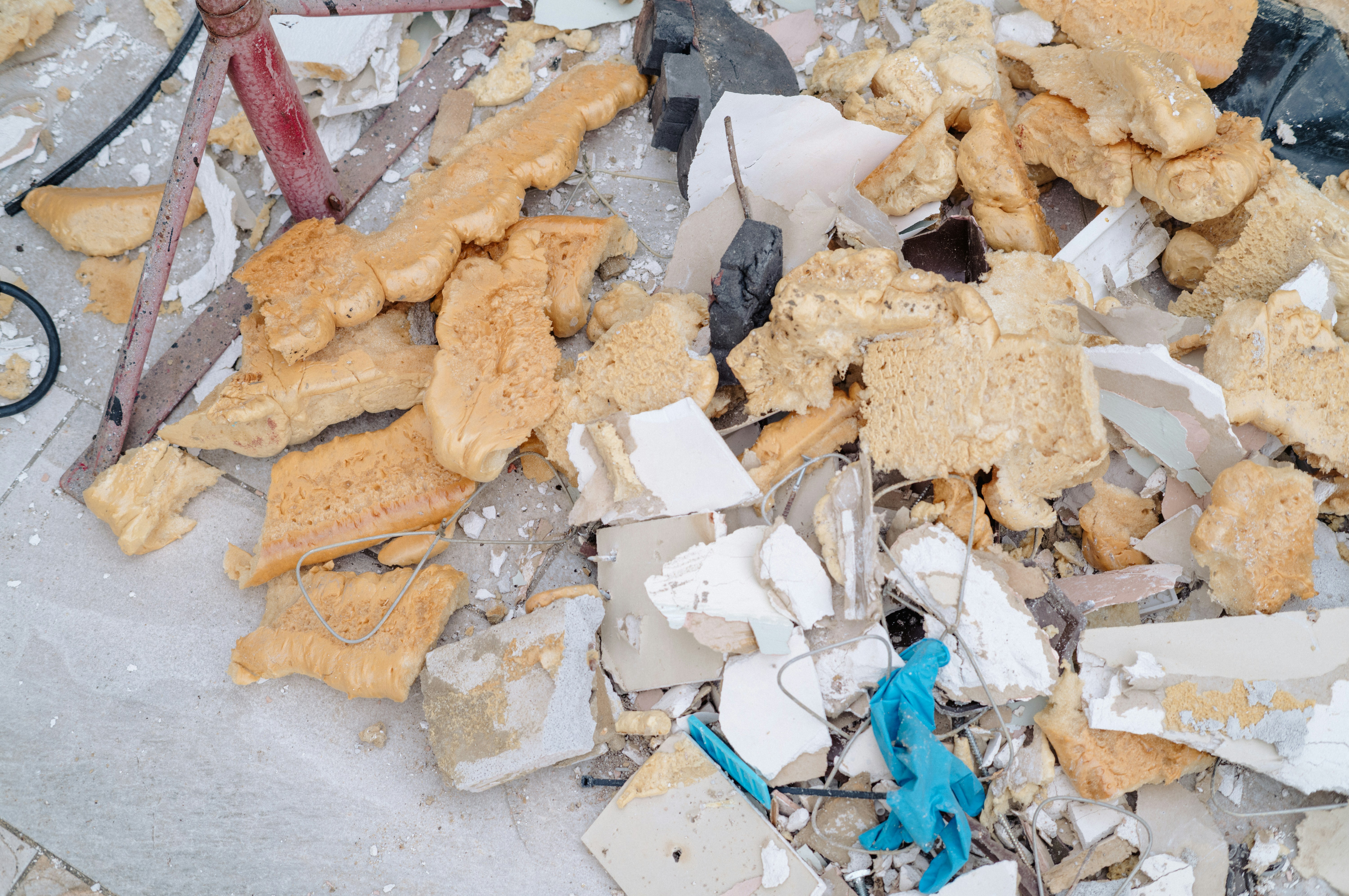 Fragmented Light: Debris and Plaster Beneath a Workbench