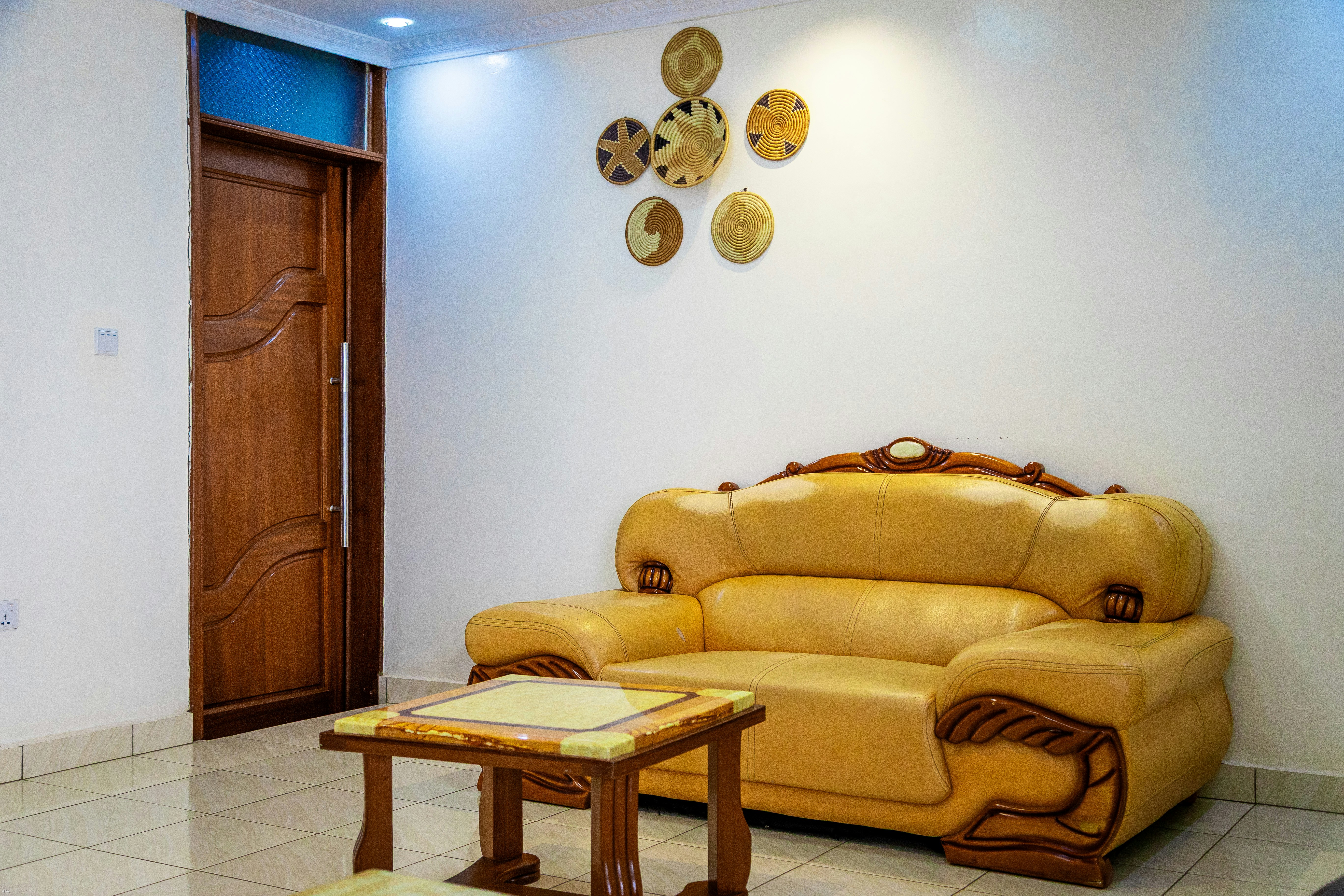 Warm Lounge Spotlight: Golden Sofa Beneath Wall Art