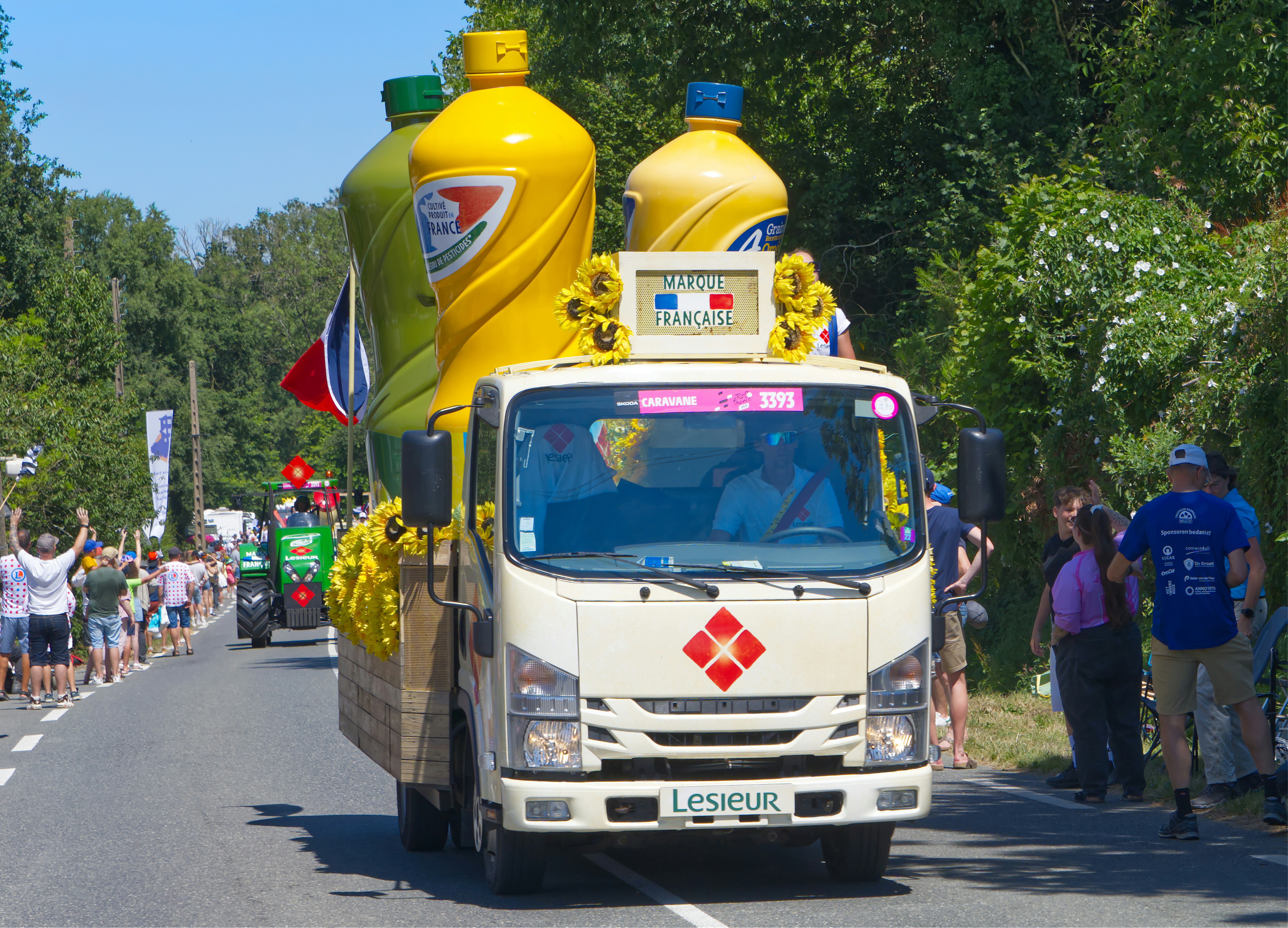Floating Colors: Parade Truck with Giant Paint Bottles Leads the Route