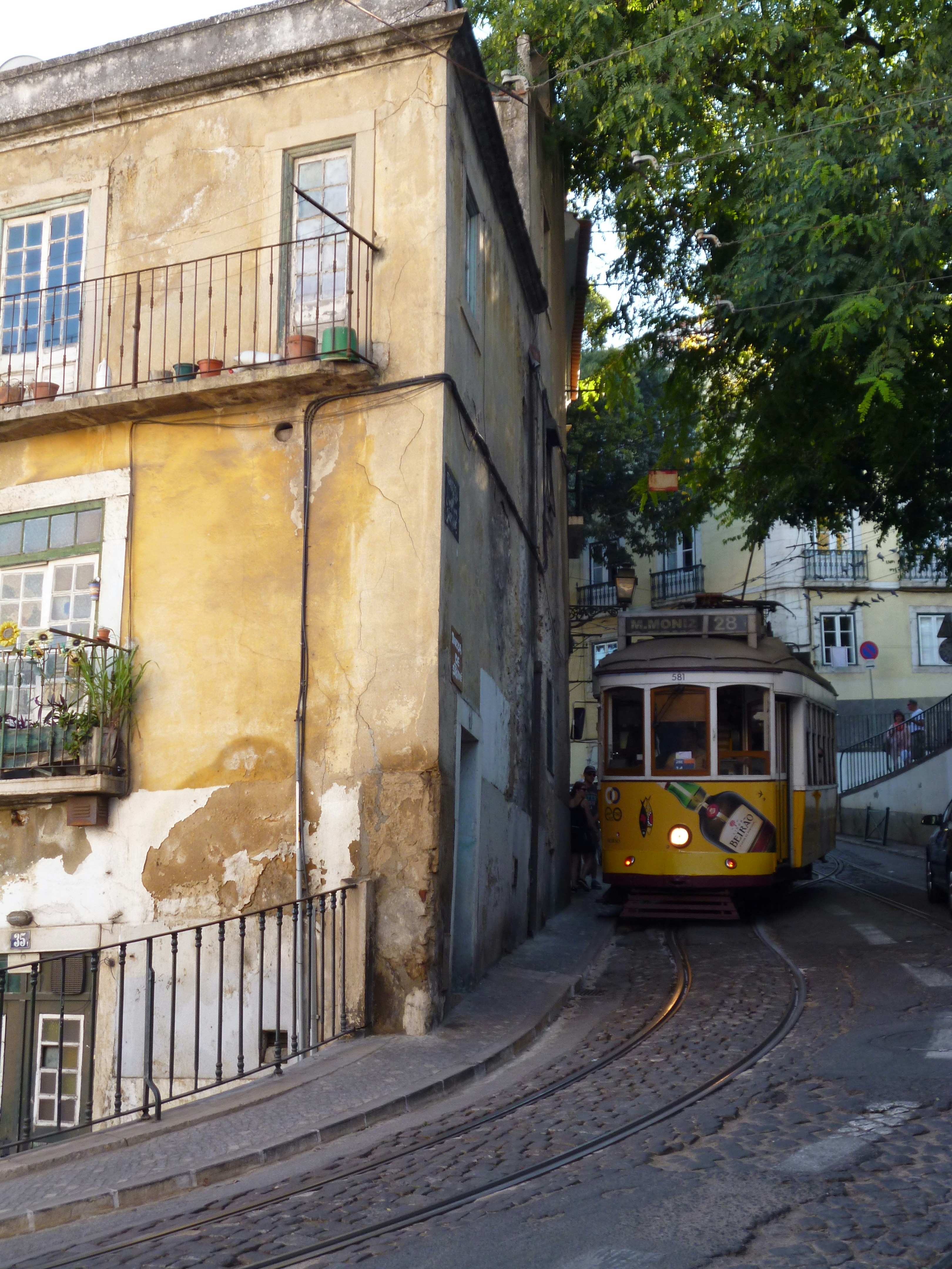Yellow Tram Slicing Through Old Town Alleys