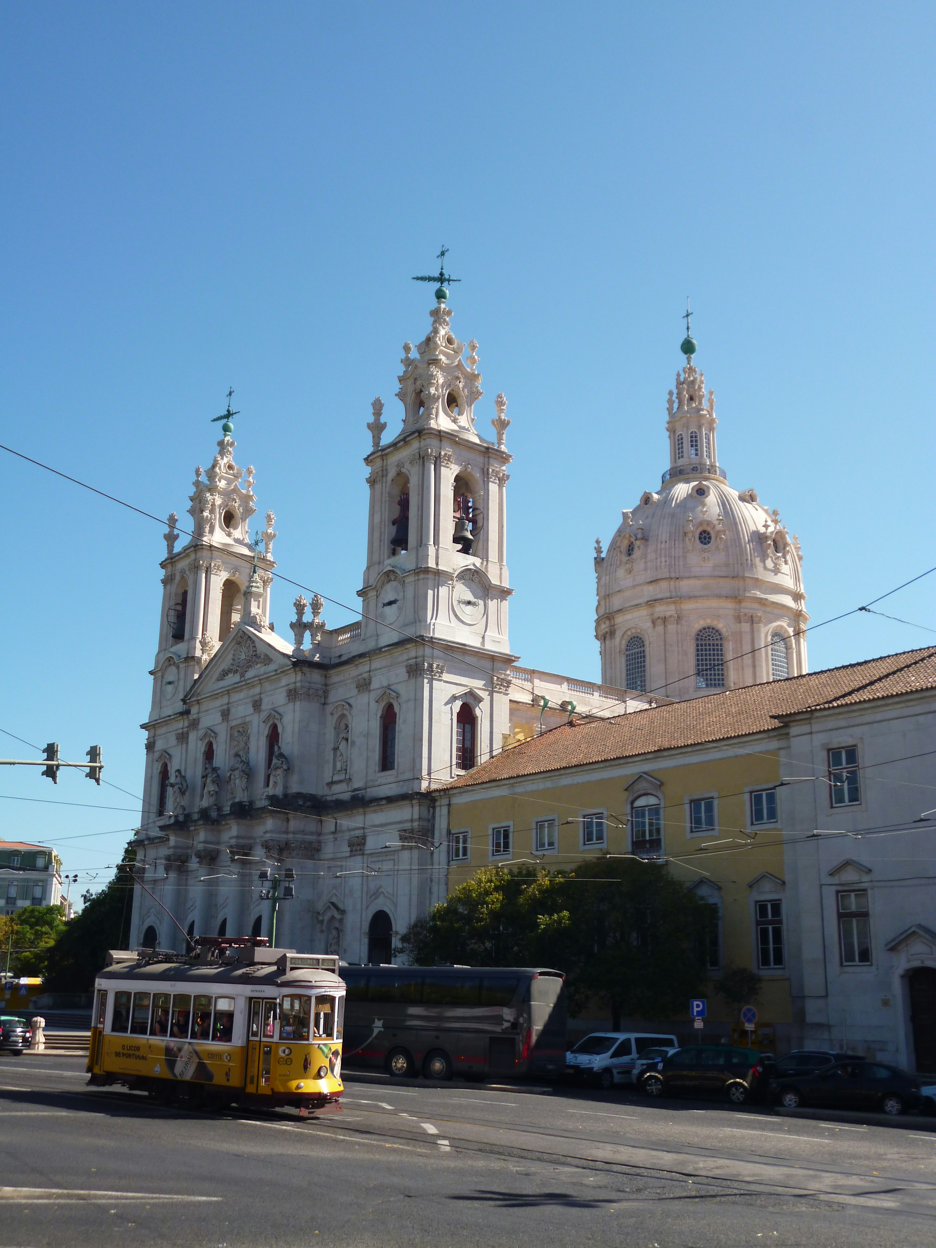 Sunlit Cathedral Facade Framed by a Vintage Streetcar
