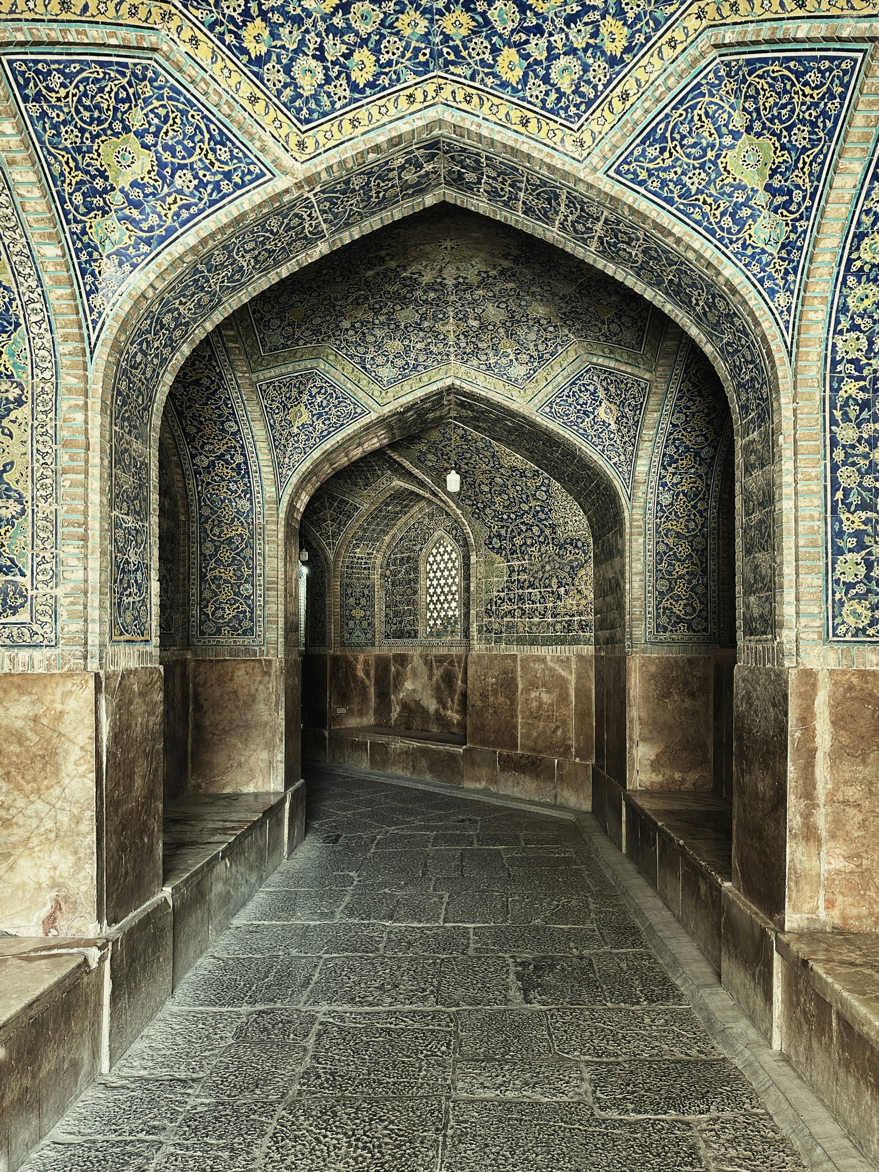 Blue-tiled Archway Corridor: A Journey Through Light and Pattern