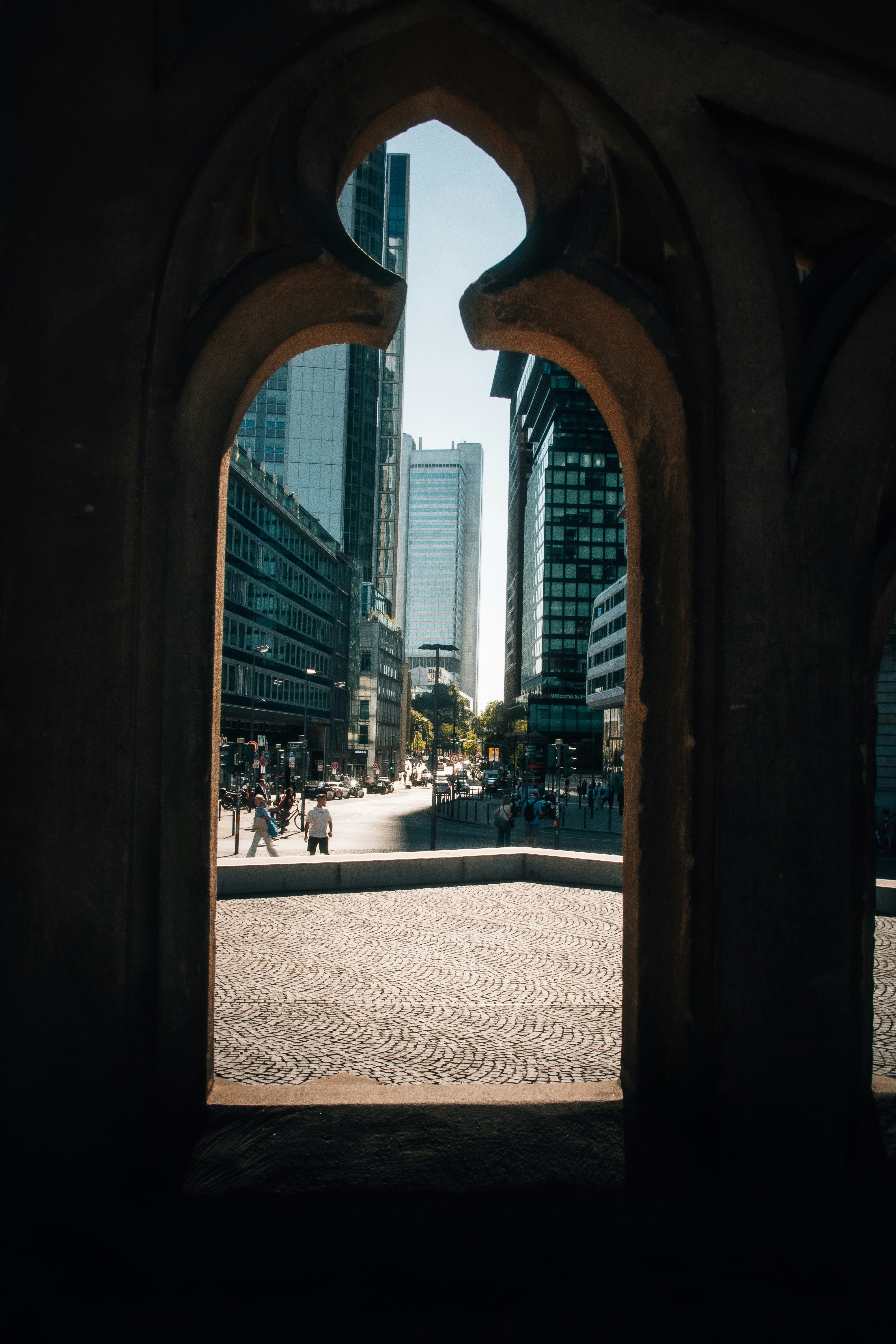 Through the Arc: City Light Framed by Ancient Stone