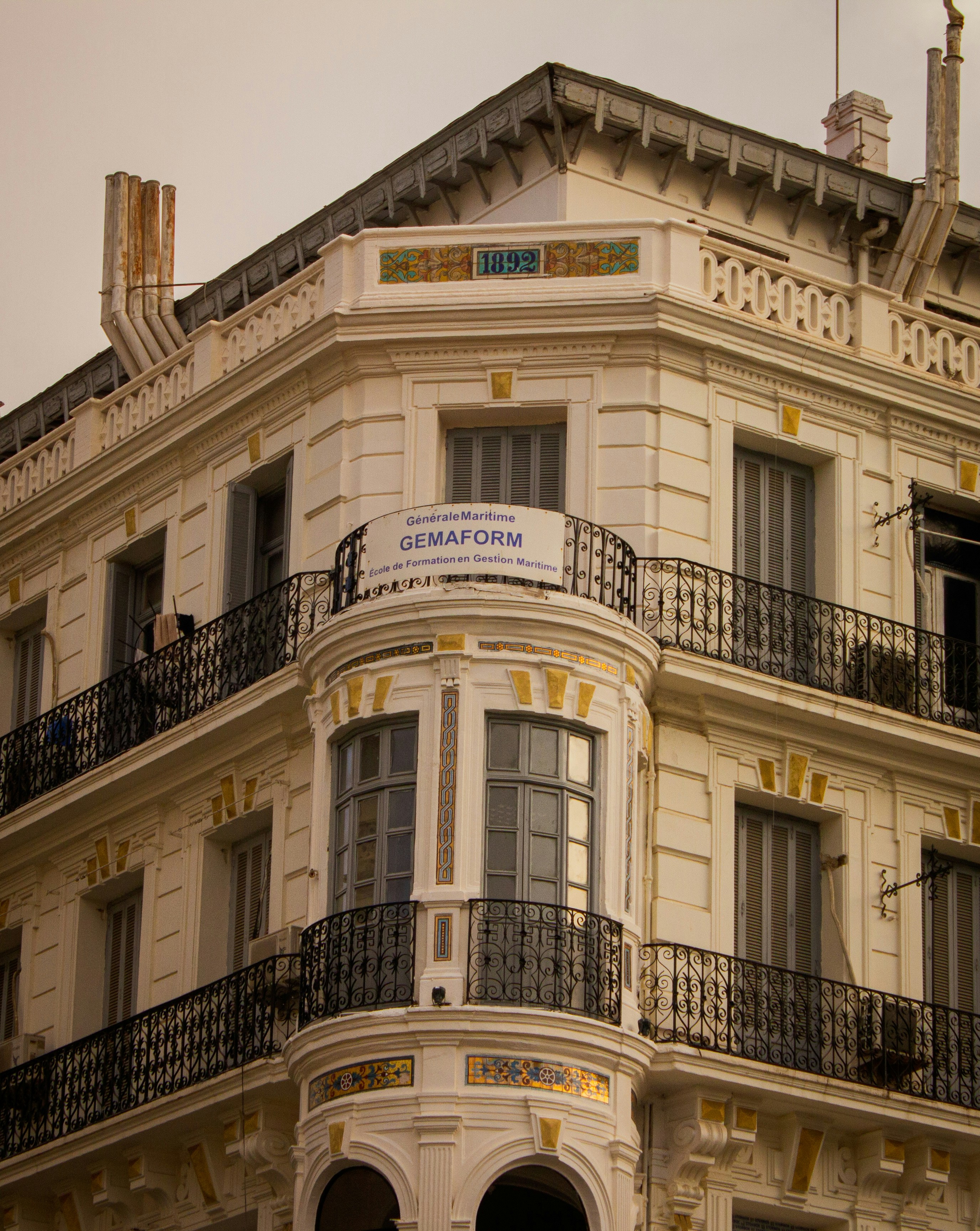 Historic Cornered Balcony: A Sunlit Facade of Elegance