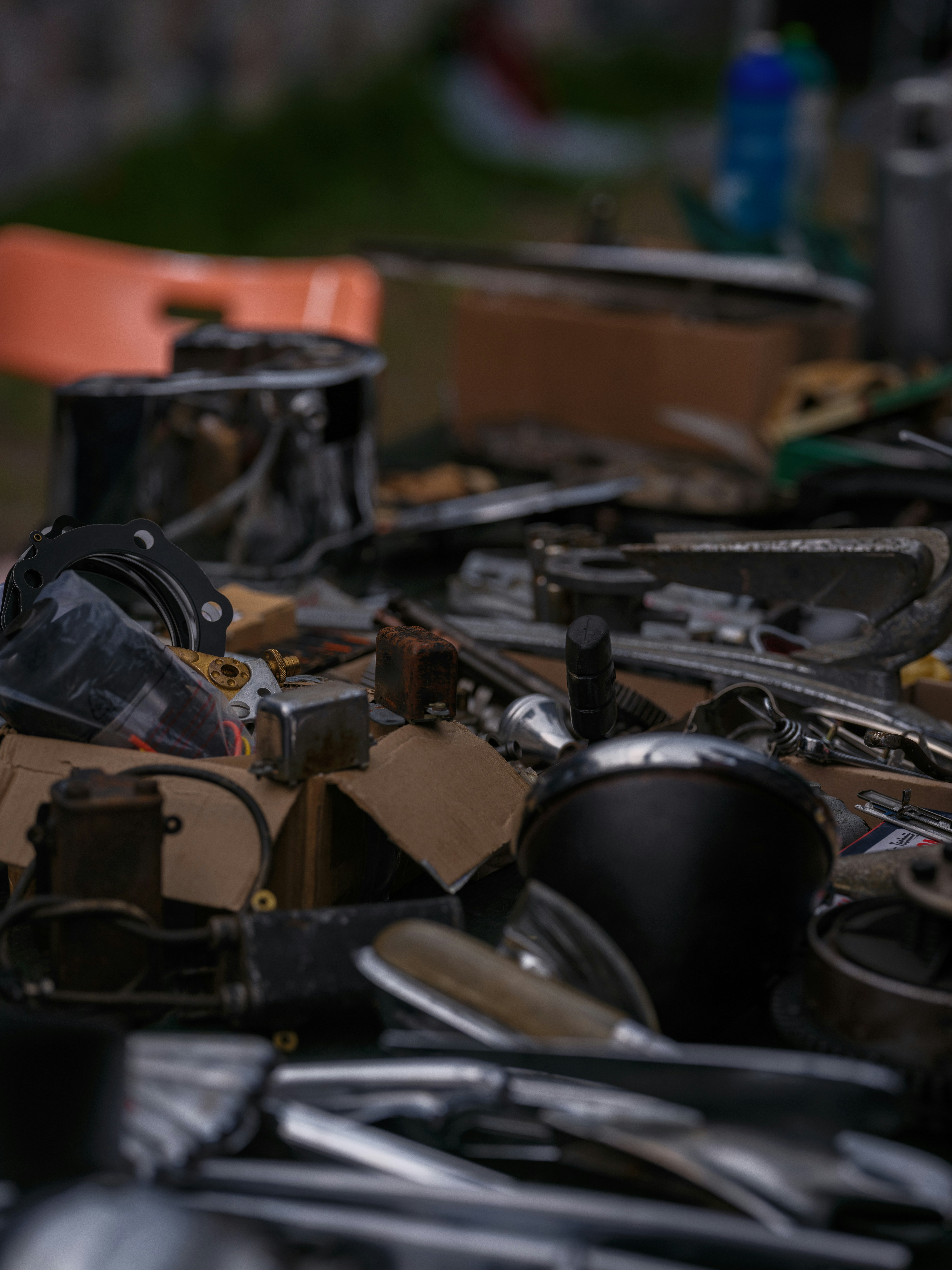 Cobbled Chaos: A Close-Up of Spare Parts and Worn Tools