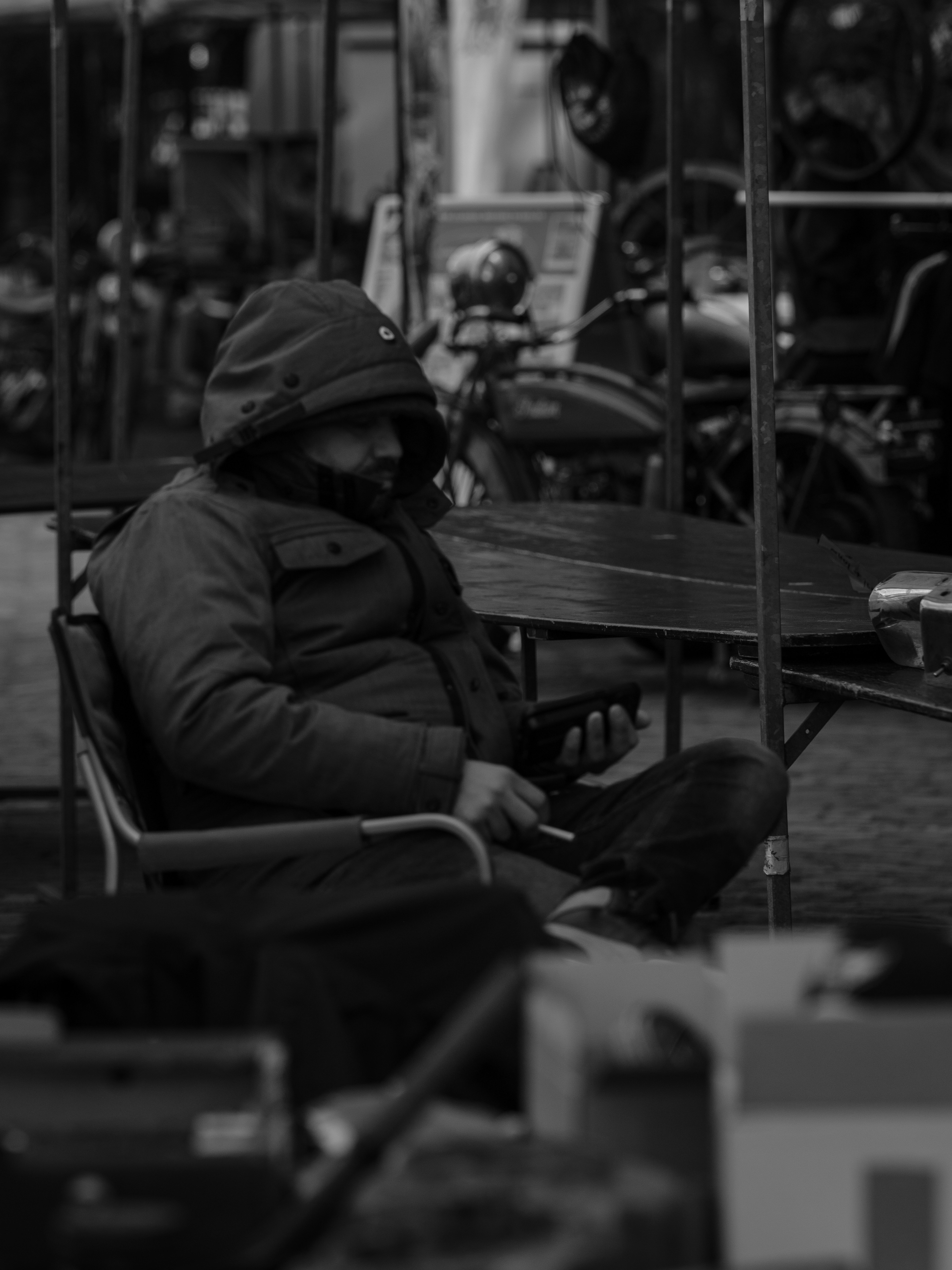 Cozy Recluse under City Chill: A Hoodie Shelter in the Street