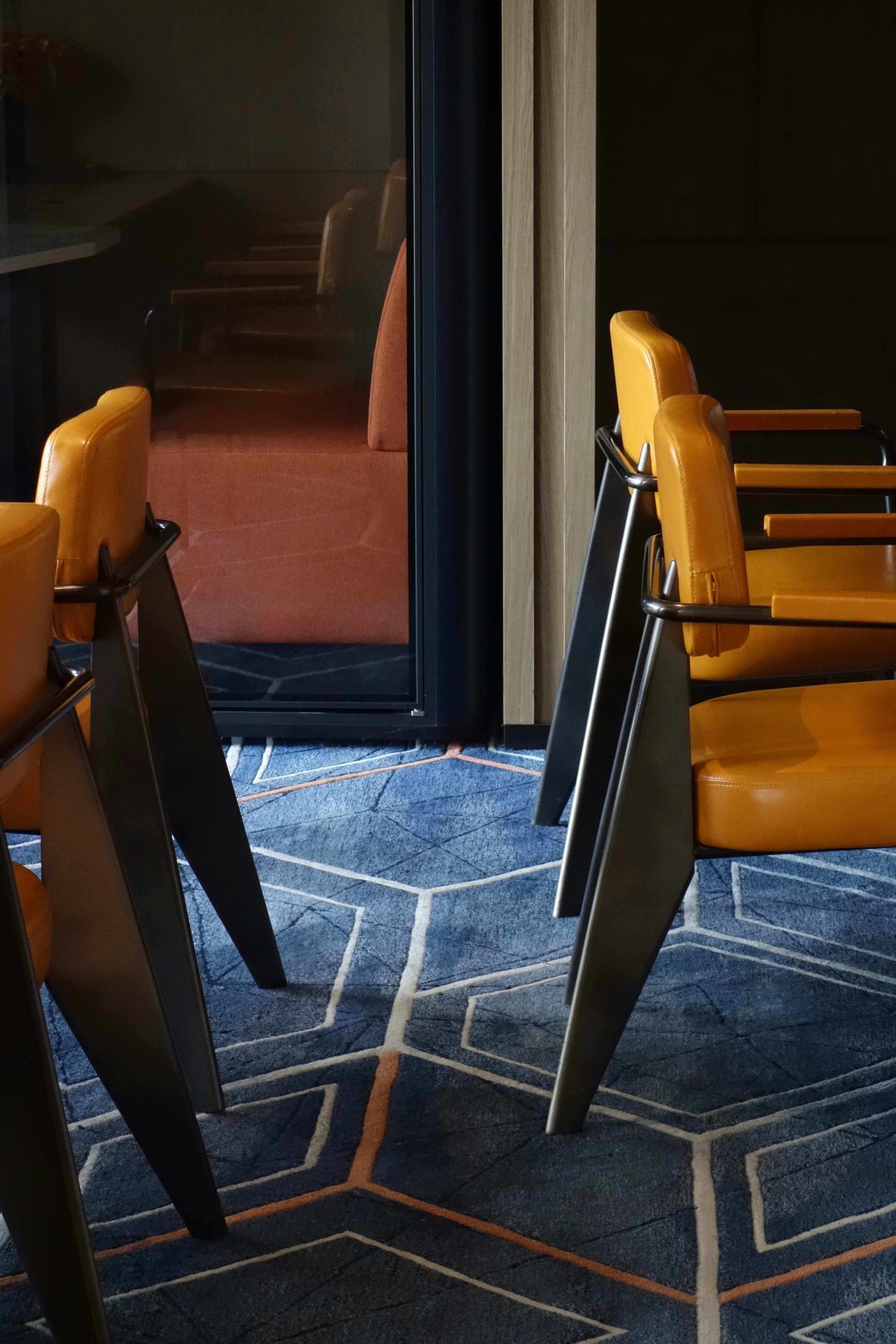 Orange Chairs Framing a Quiet Corridor