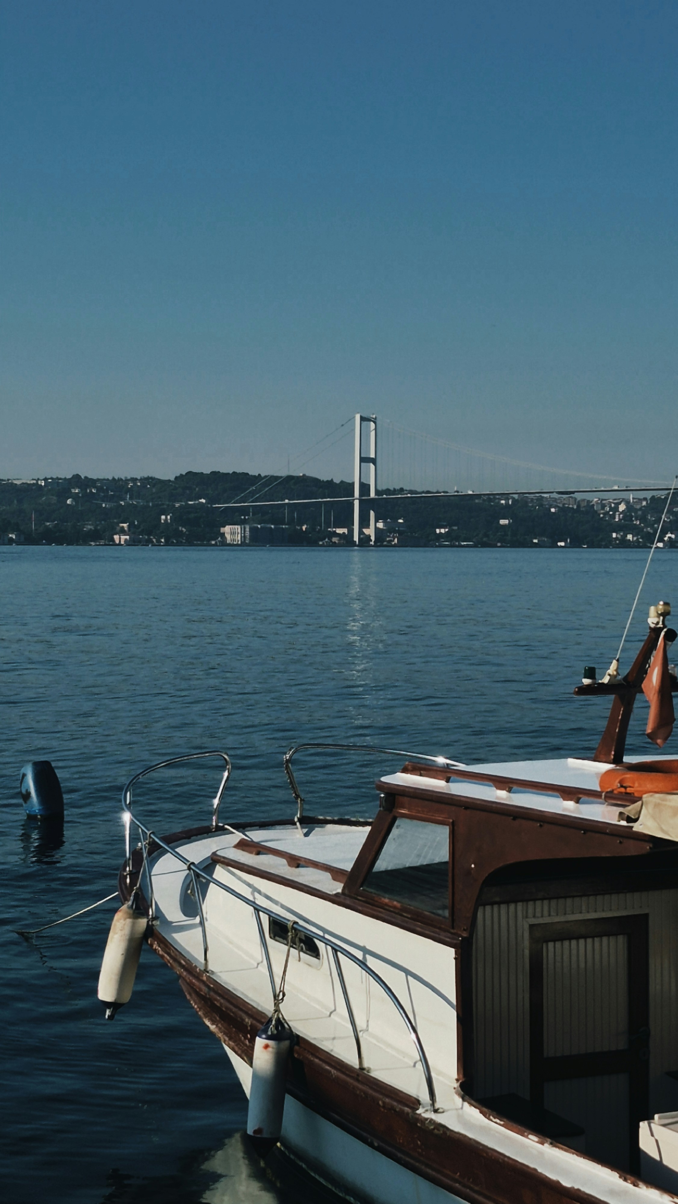 Docked at Dusk: A Sailboat Meets a Quiet Skyline