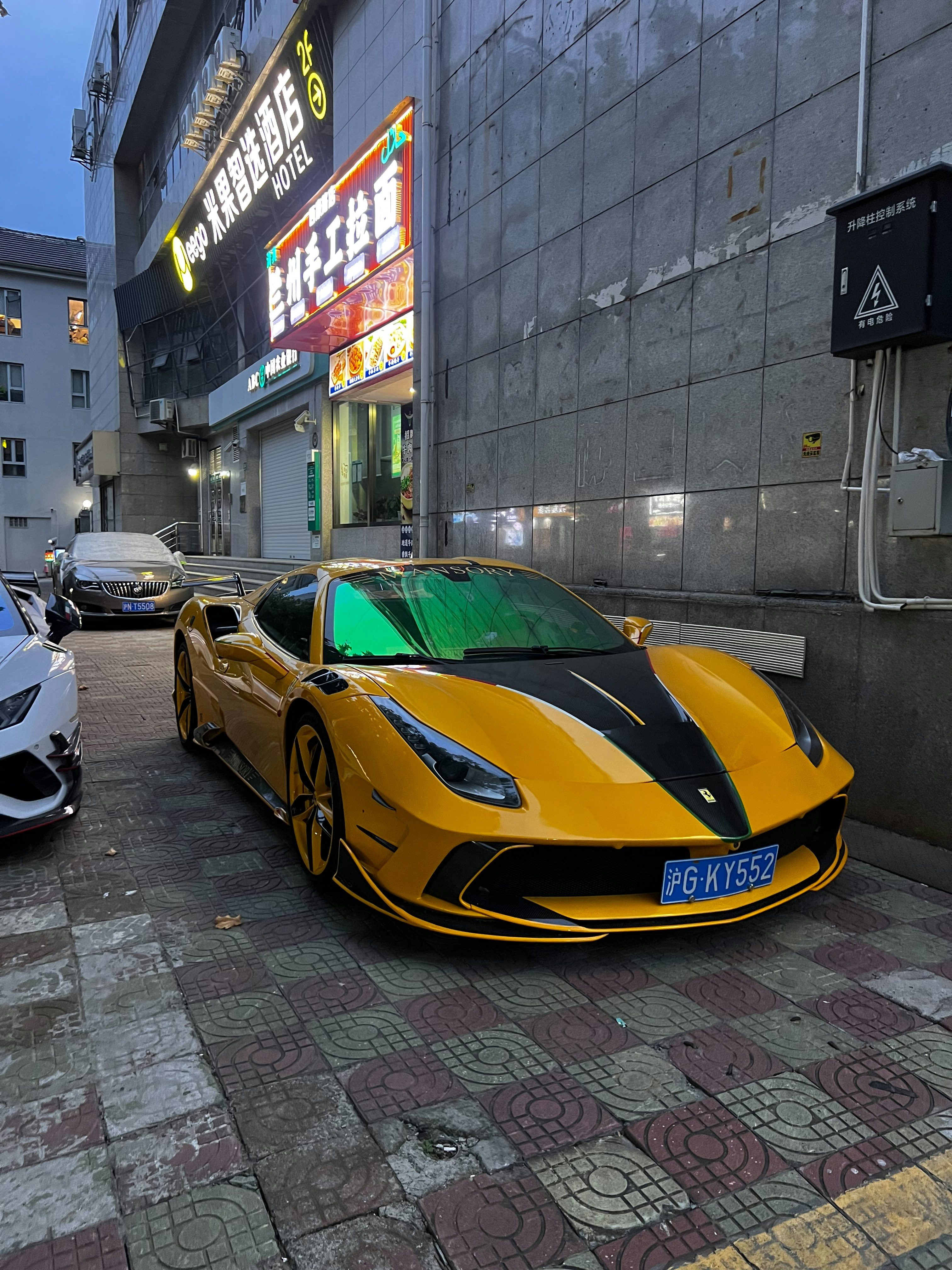 Golden Ferrari in an Urban Alleyway at Dusk