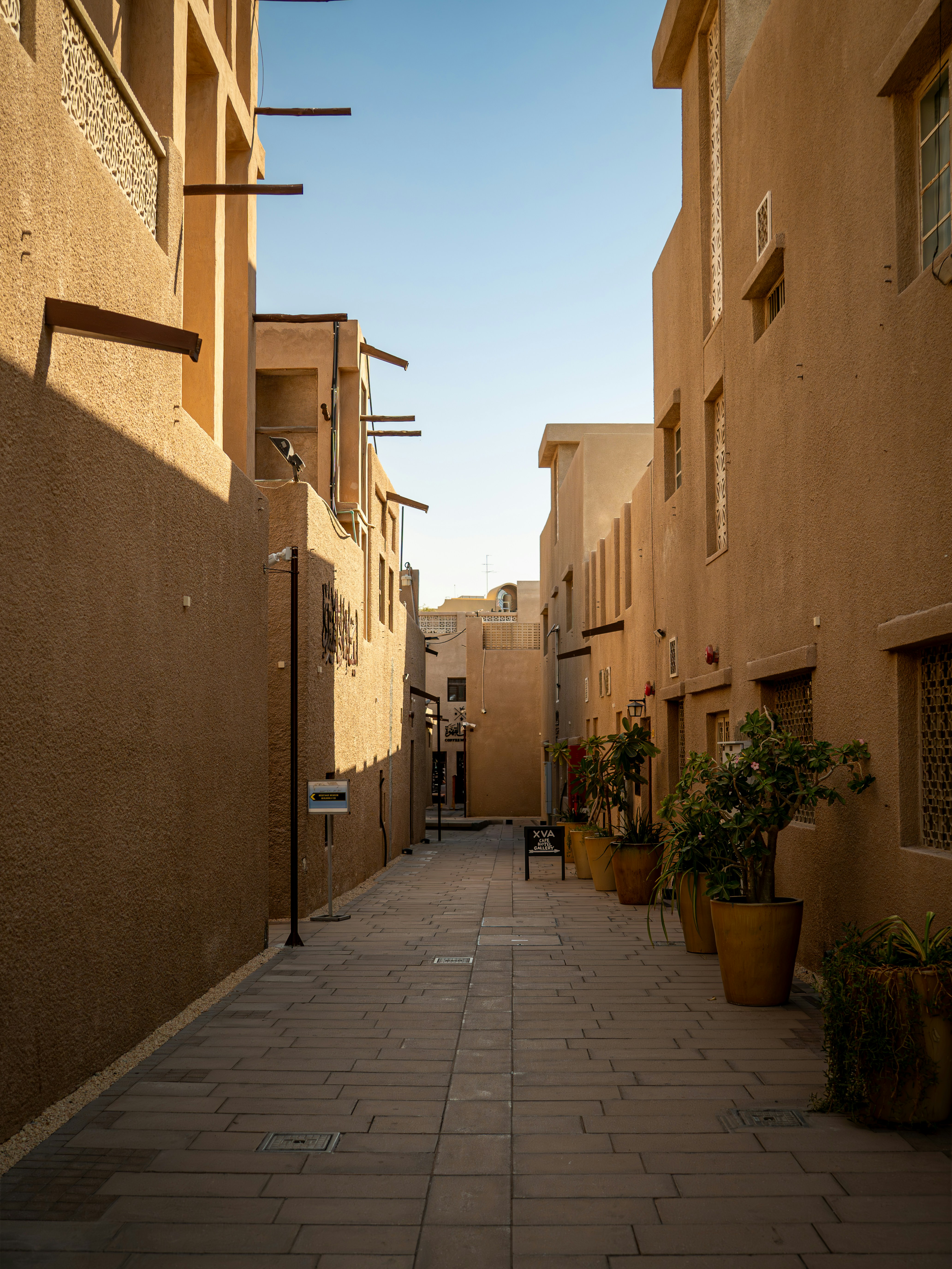 Sunlit Alleyway: Quiet Symmetry Between Sandstone Walls