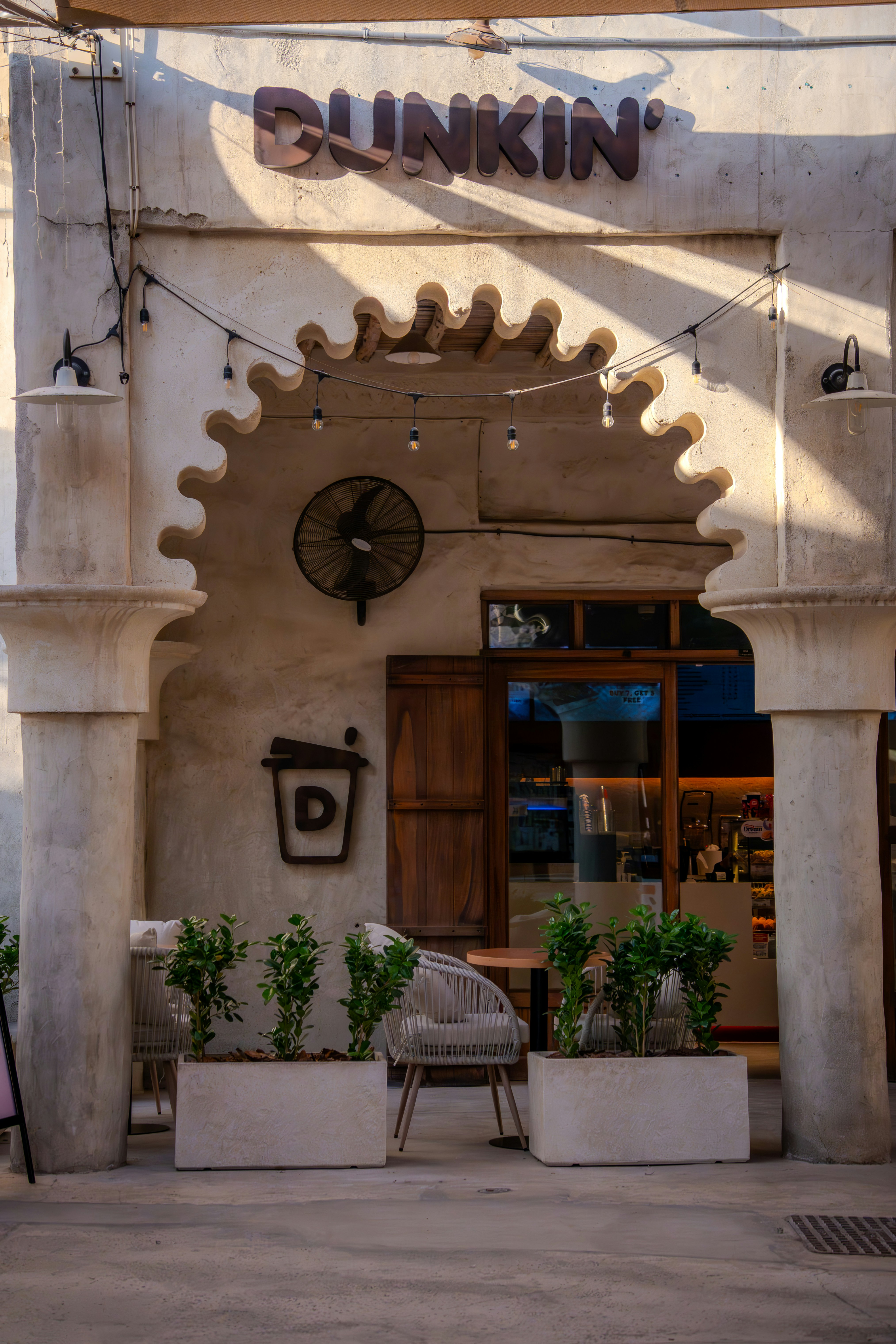 Dunkin' Archway: A Quiet Café Entrance Framed by Classic Columns