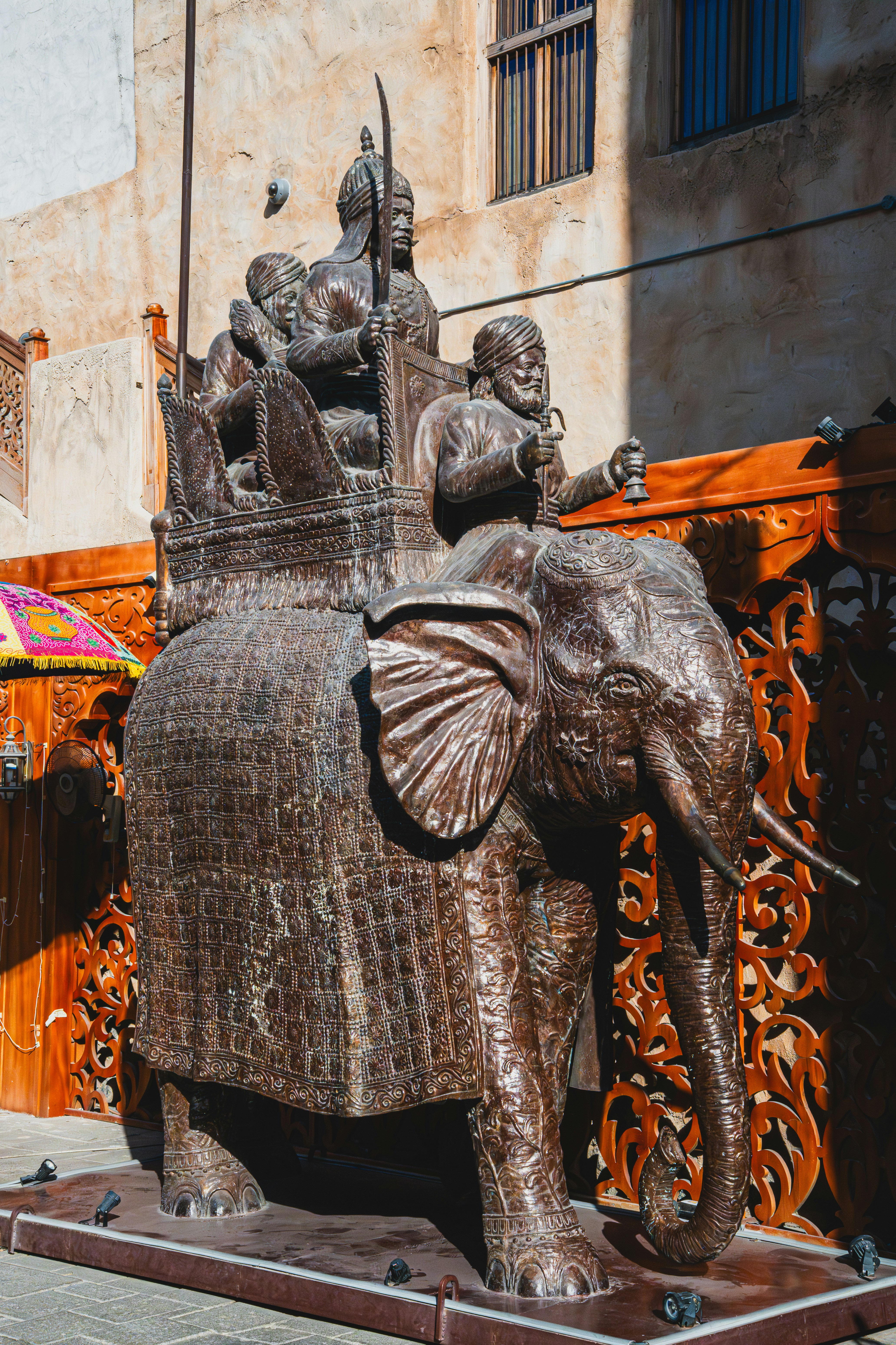 Carved Elephant Arsenal: Bronze Statues on a Crimson Stage